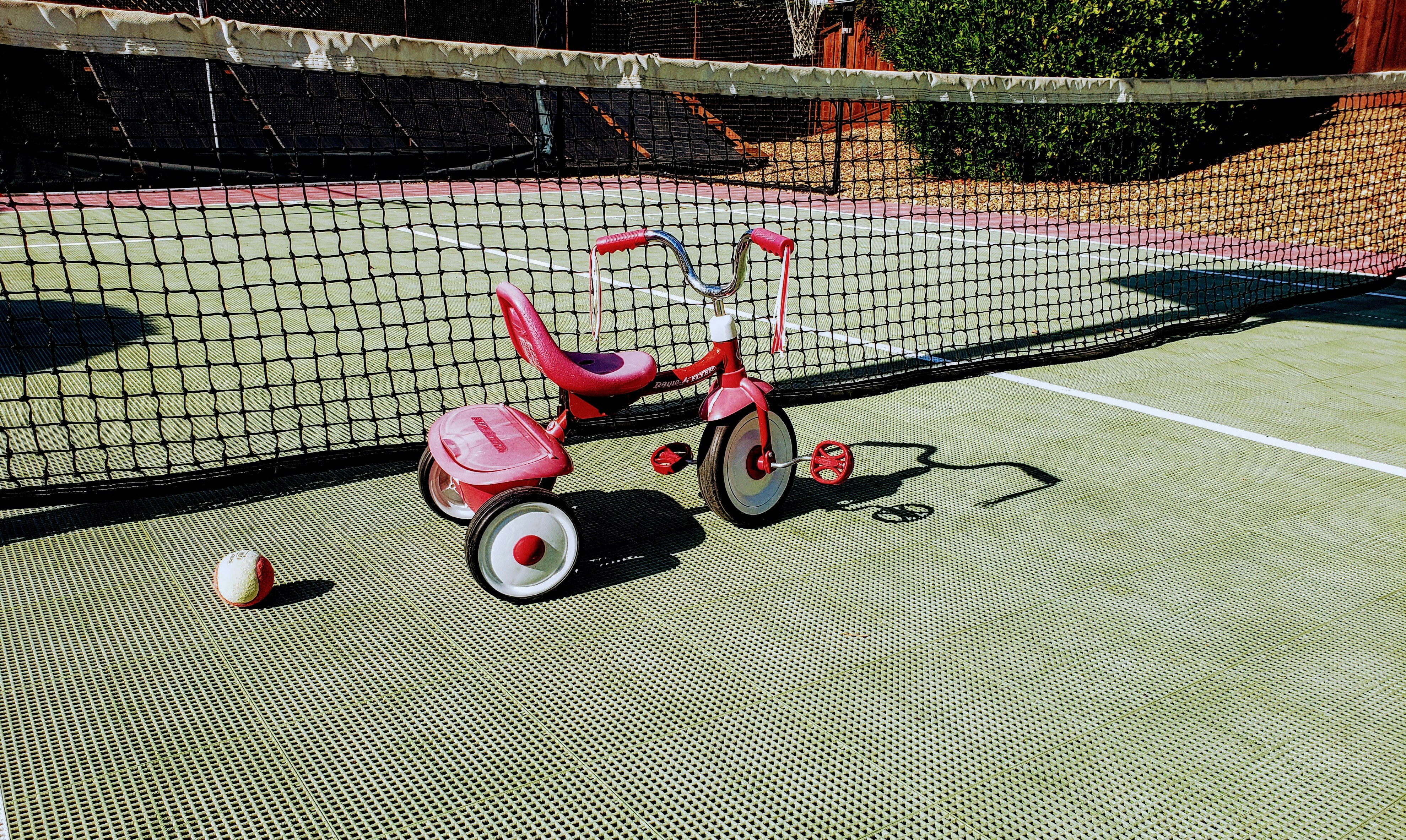 red and white Radio Flyer trike close-up photography