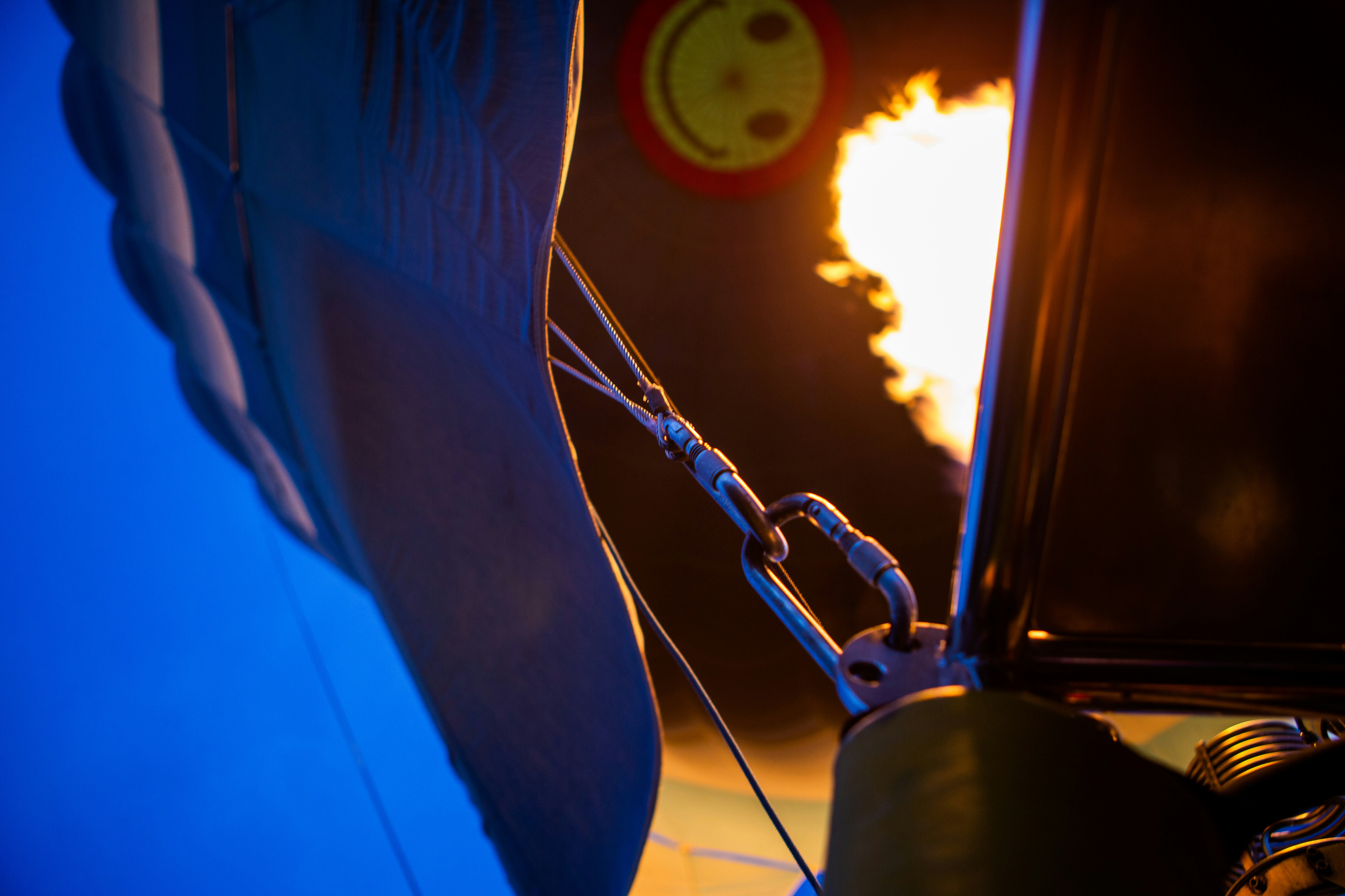 Blue Shadow and Flame: An In-Frame View Inside a Hot Air Balloon Harness
