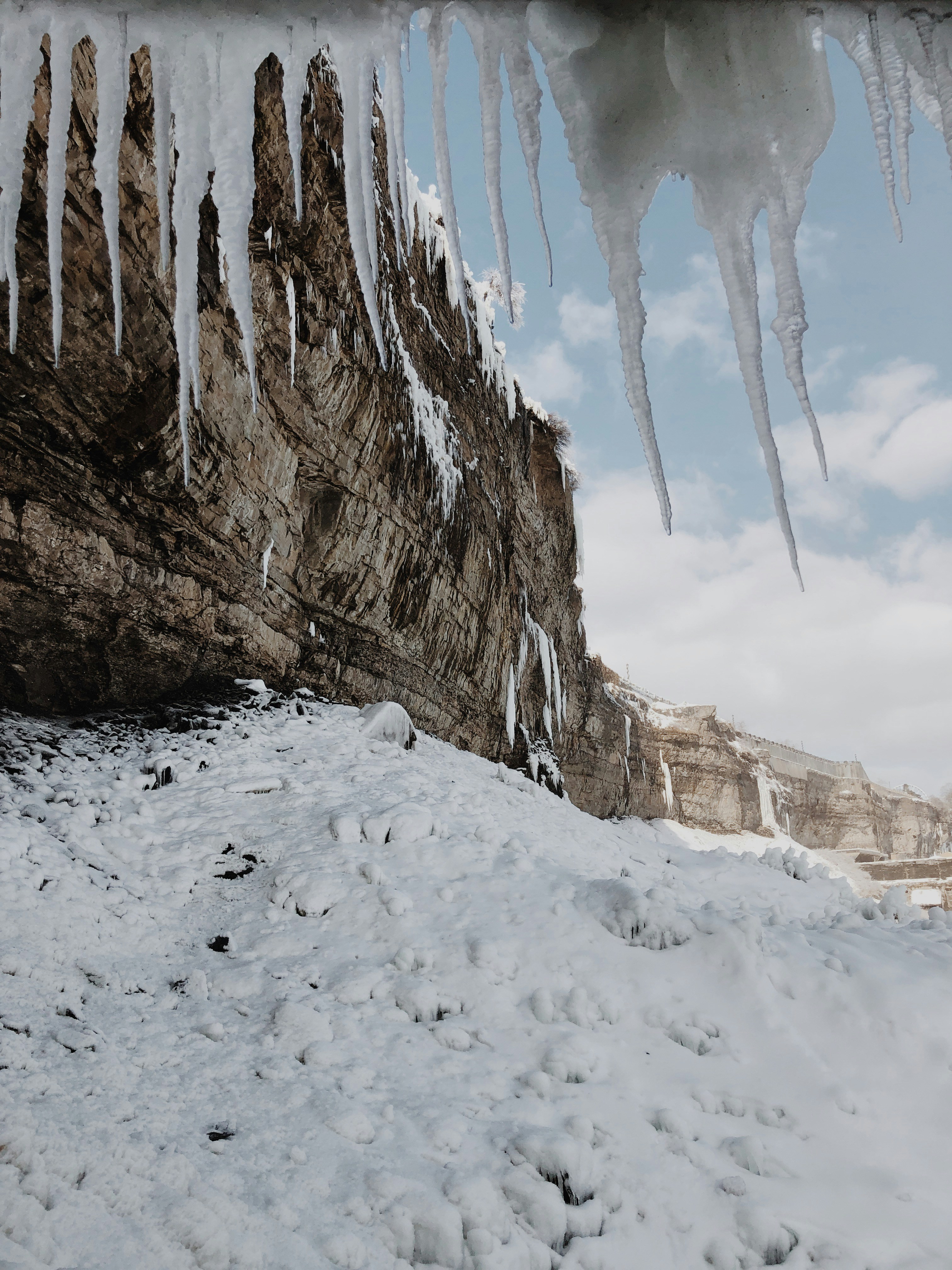 Icicle Veils Over a Snowbound Cliff