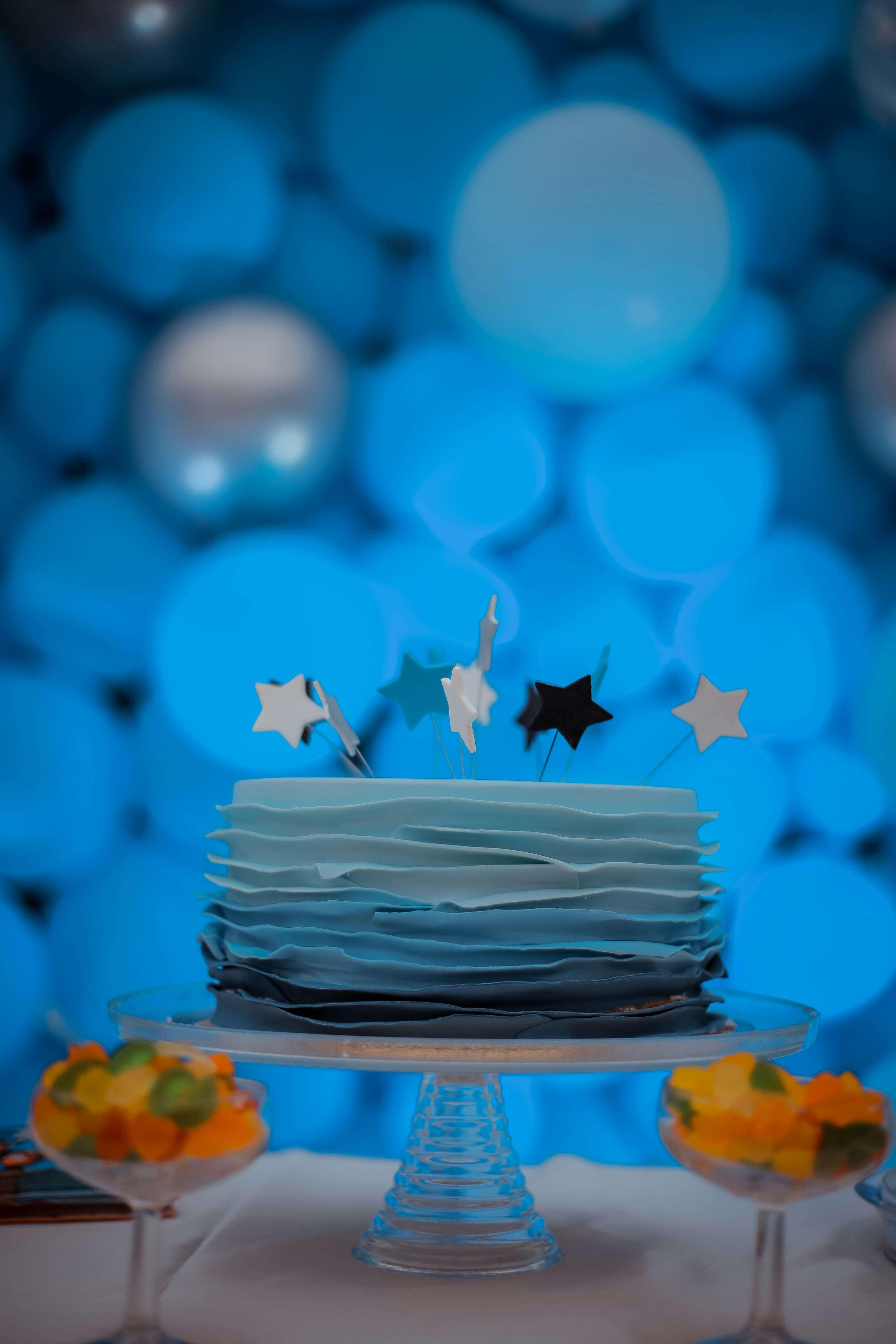 Blue Velvet Cascade: A Birthday Cake on a Glass Pedestal