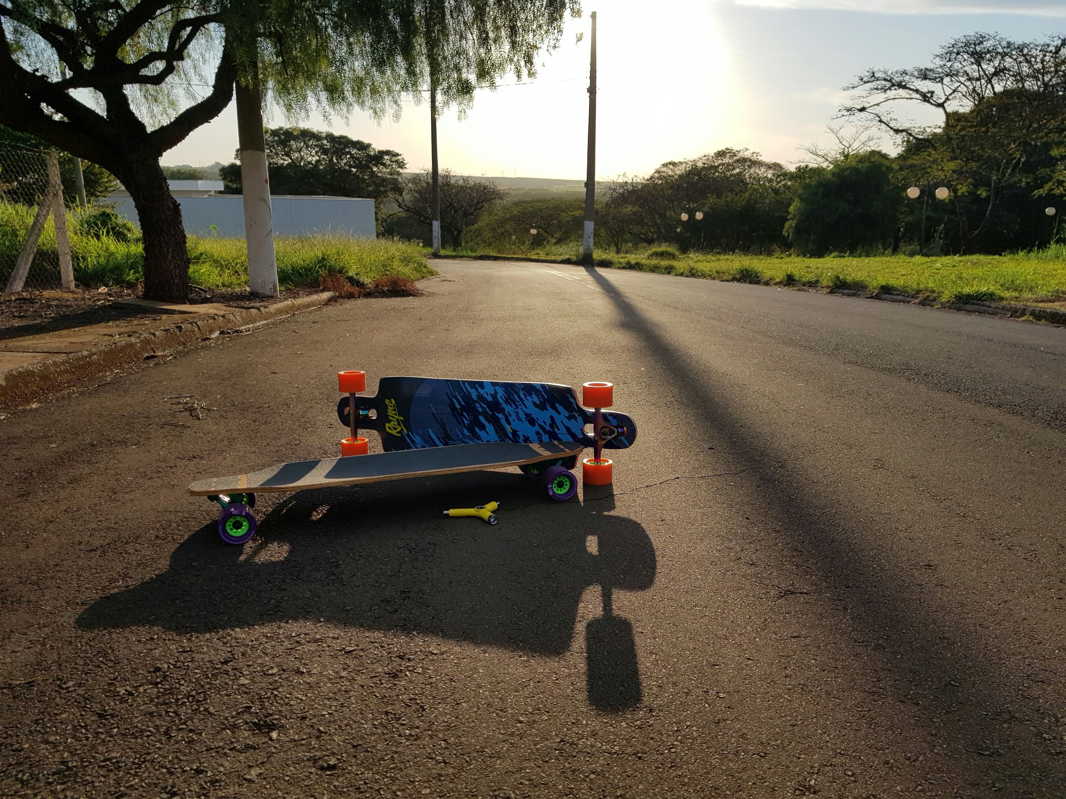 Two assorted-color longboards on road photo – Free Street Image on Unsplash