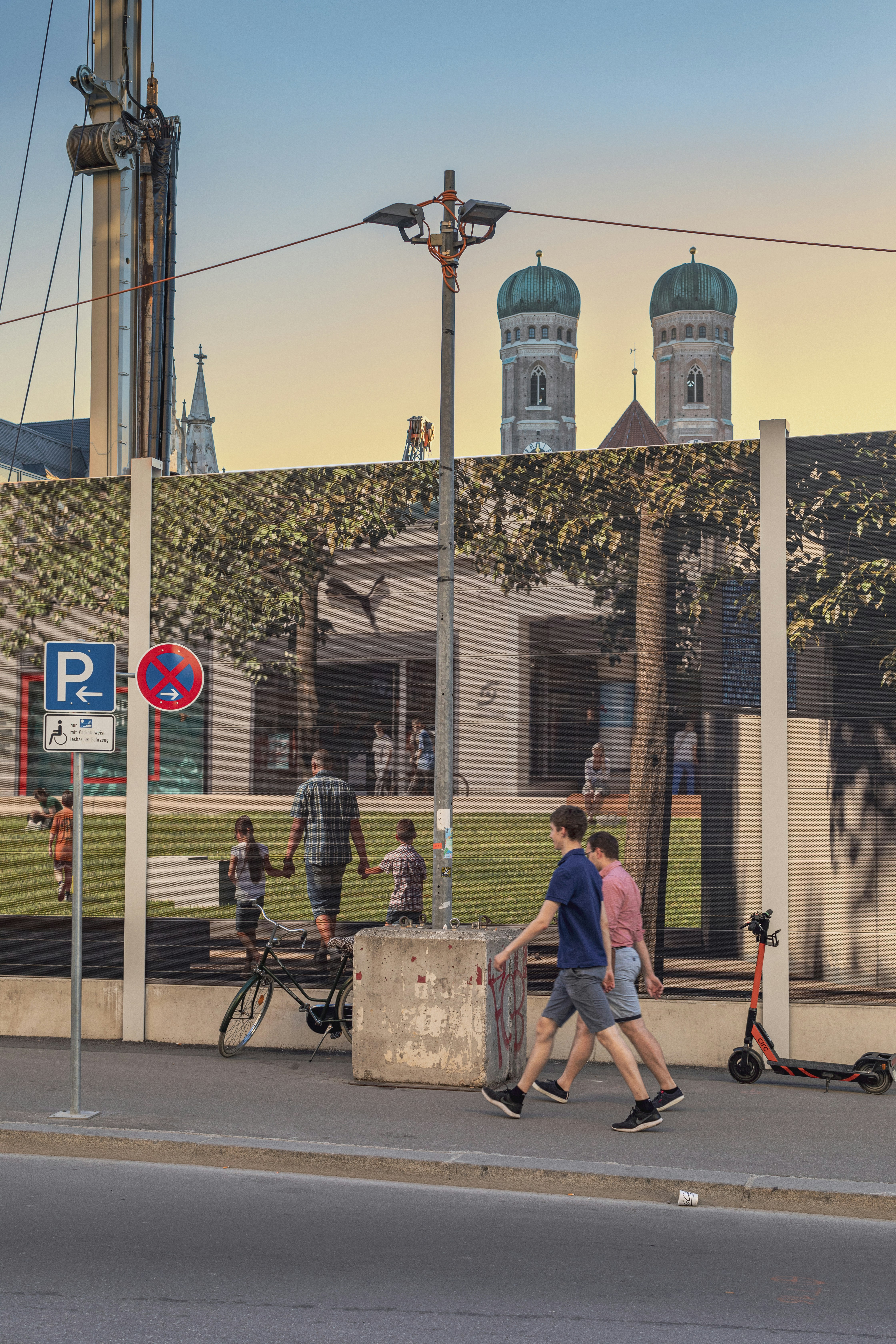 Glass Facade, Ivy, and Twin Domes: A Street-Level Vista at Dusk