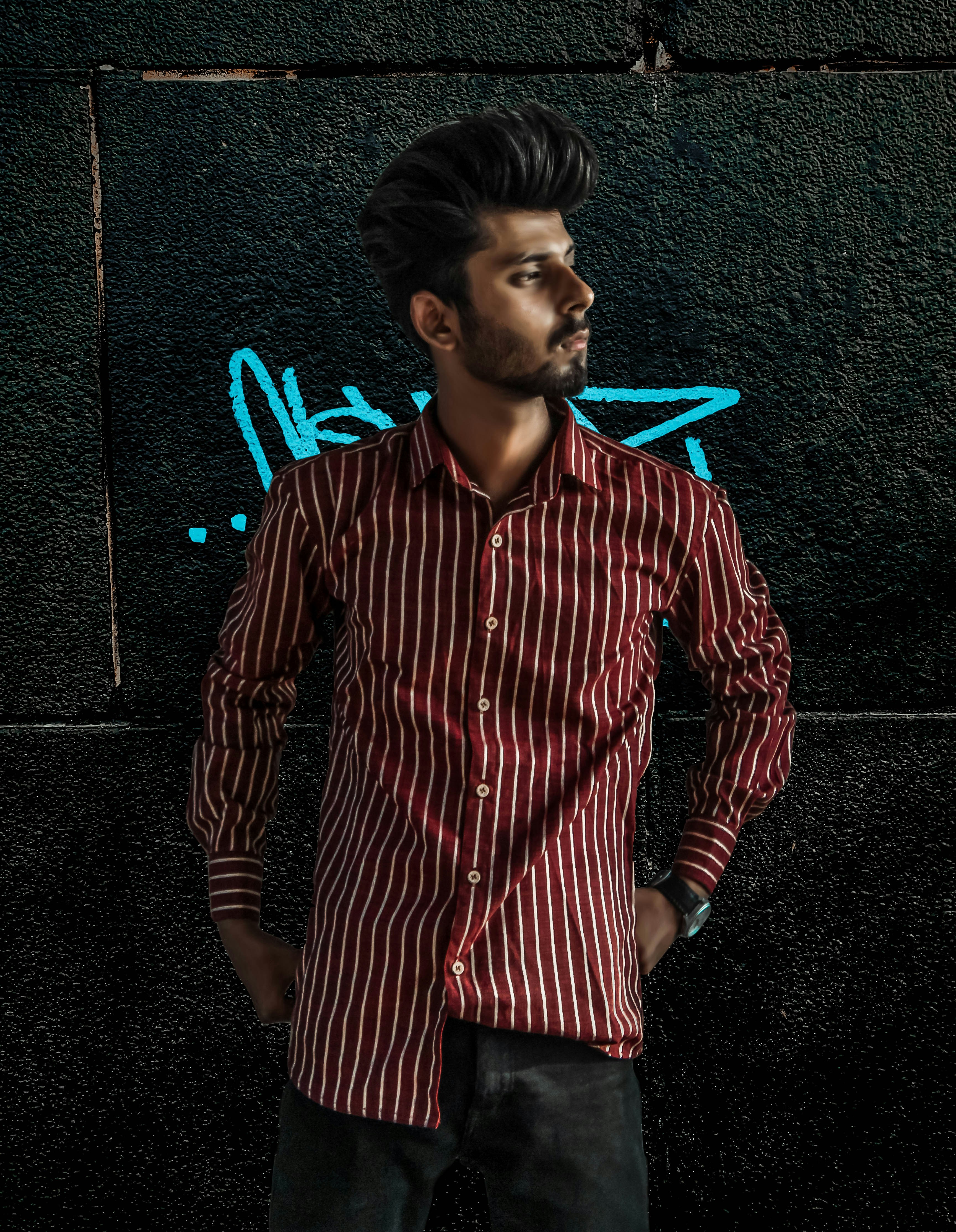 Crimson Stripes Against Concrete: A Quiet Portrait with Turquoise Flair