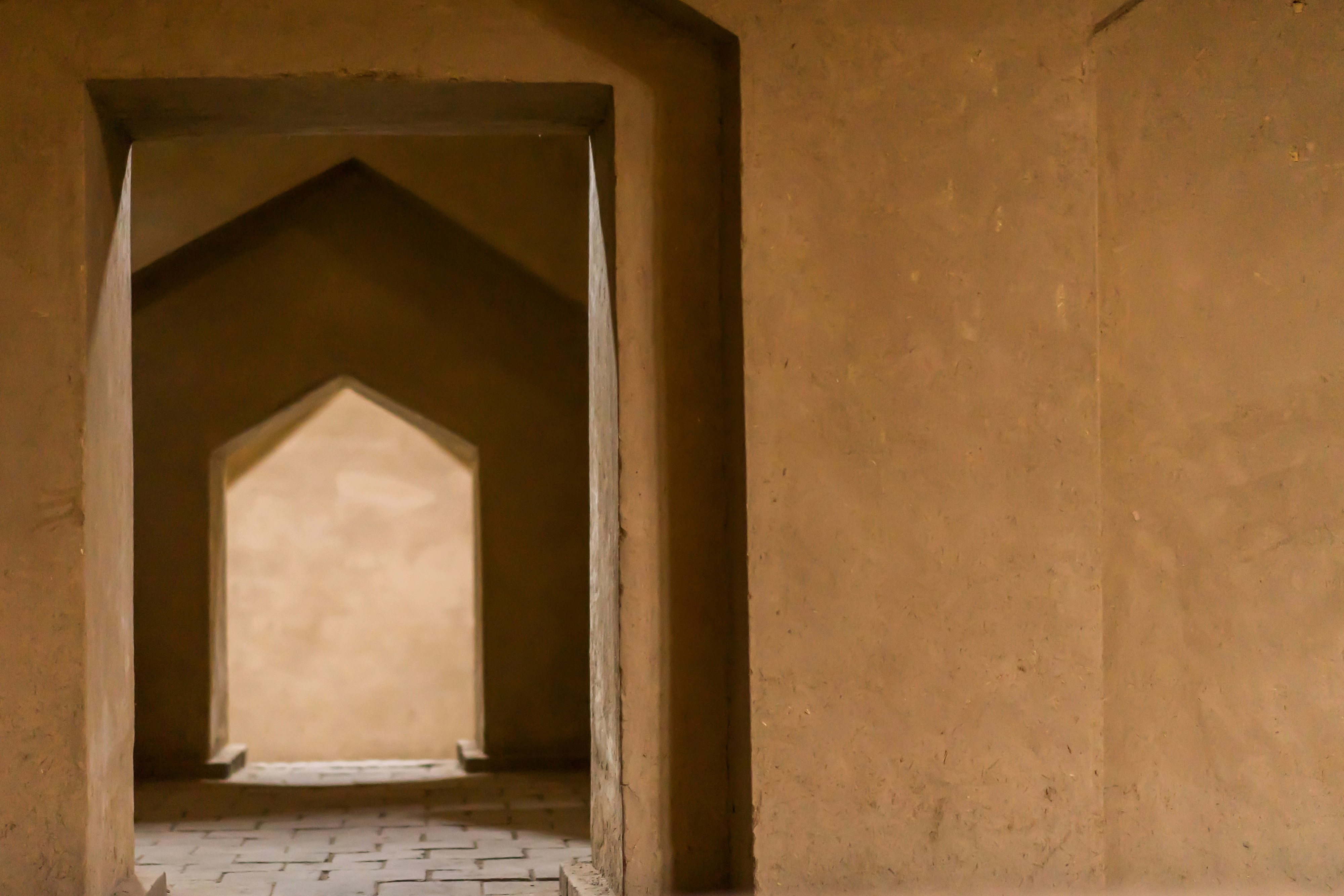 A narrow passageway between two walls in a building photo – Free Brown ...