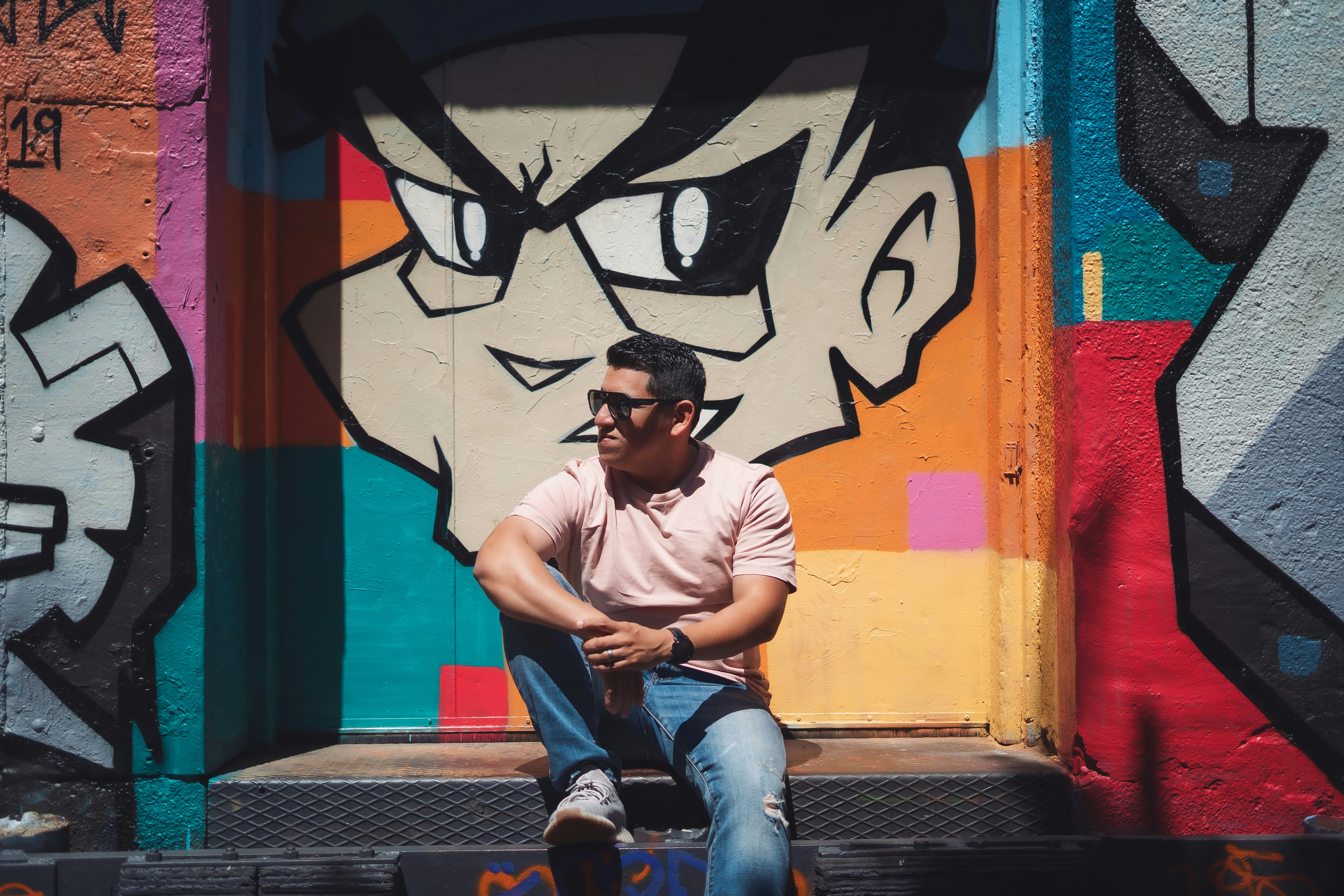Graffiti Portrait: A casual moment against a comic mural