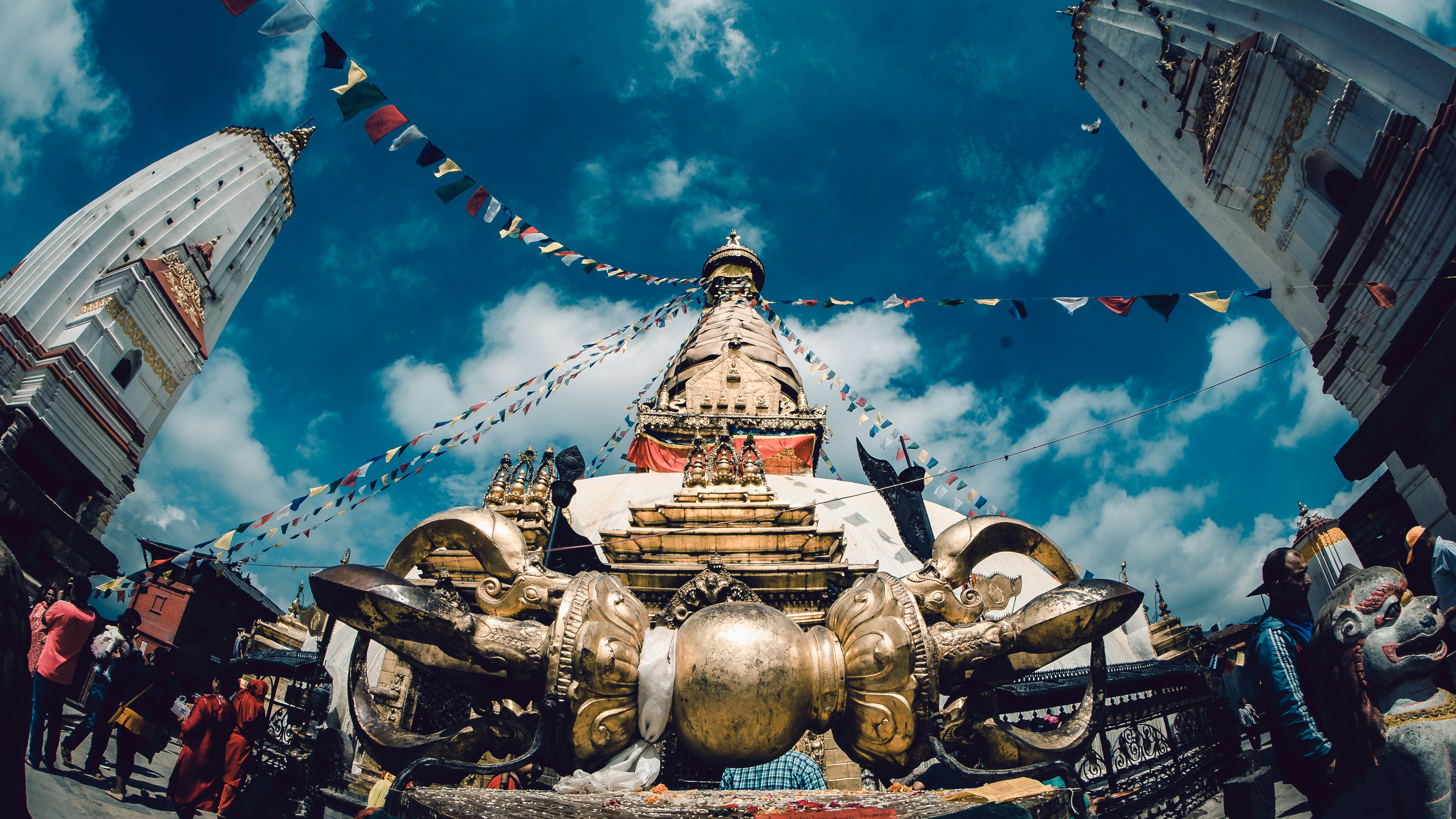 Brass Guardian at the Temple's Heart, Framed by Prayer Flags