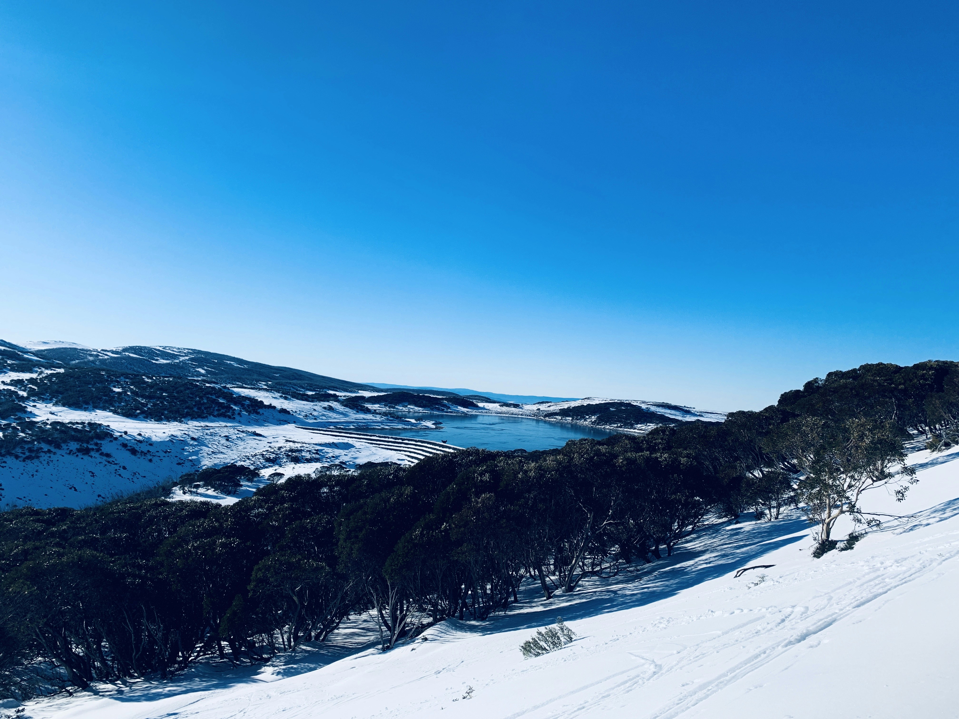 Blue Quiet: Snow-Capped Ridge Framing a Glassy Lake