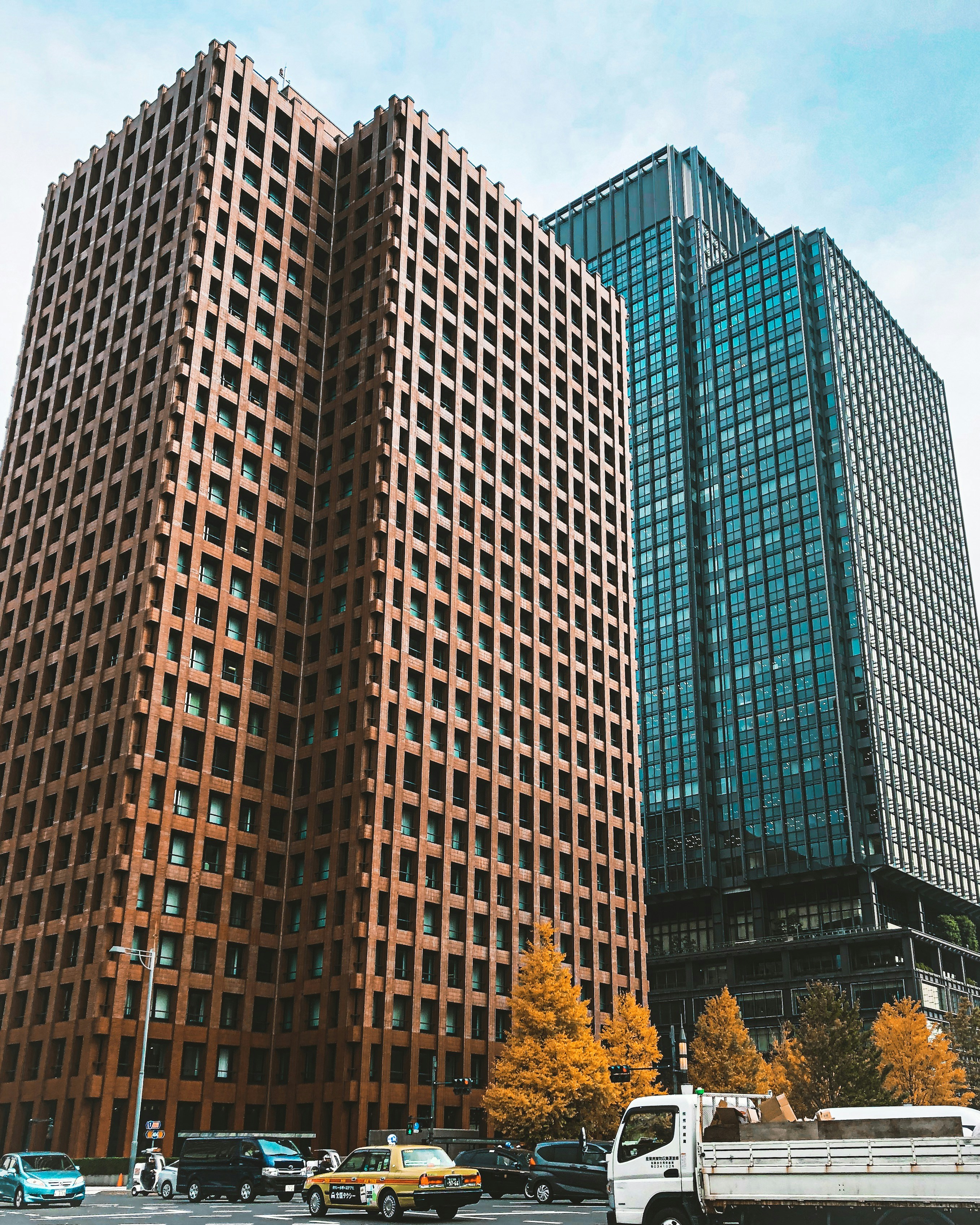 Brick Giants Against a Glass Skyline: Autumn Street Scene