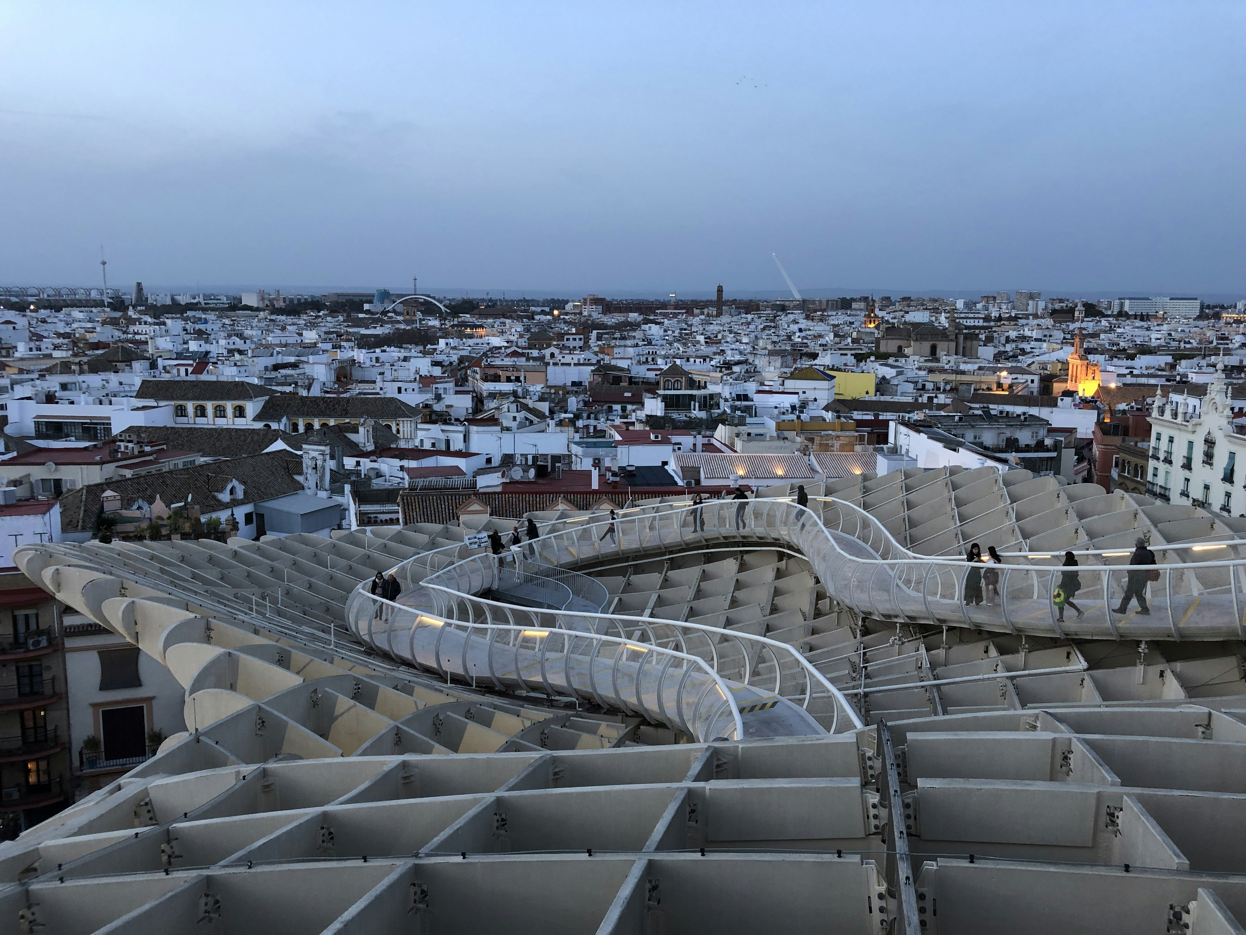 Serpentine Skywalk Above a Tiled City at Blue Hour
