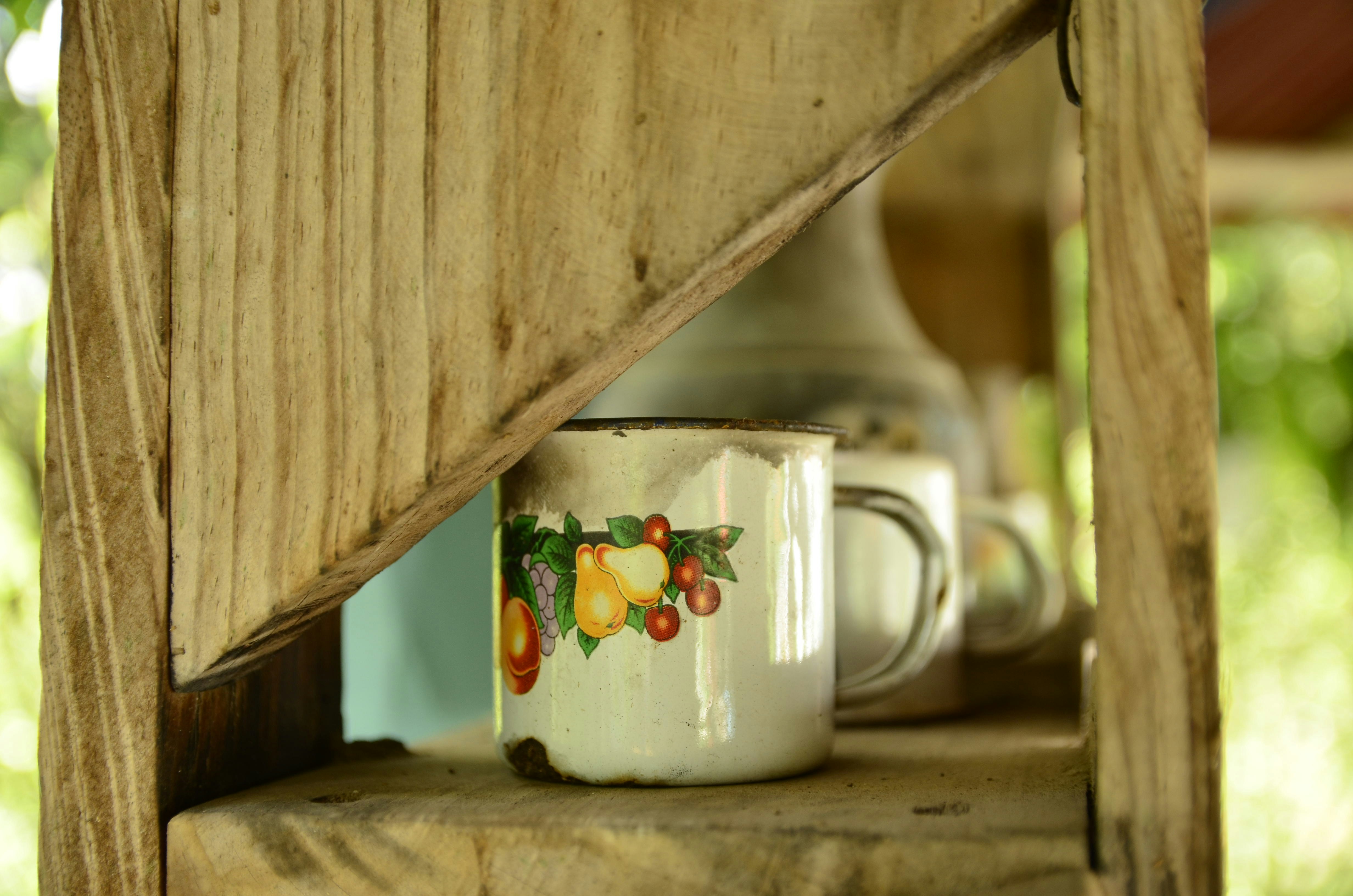 white and multicolored fruit print mug