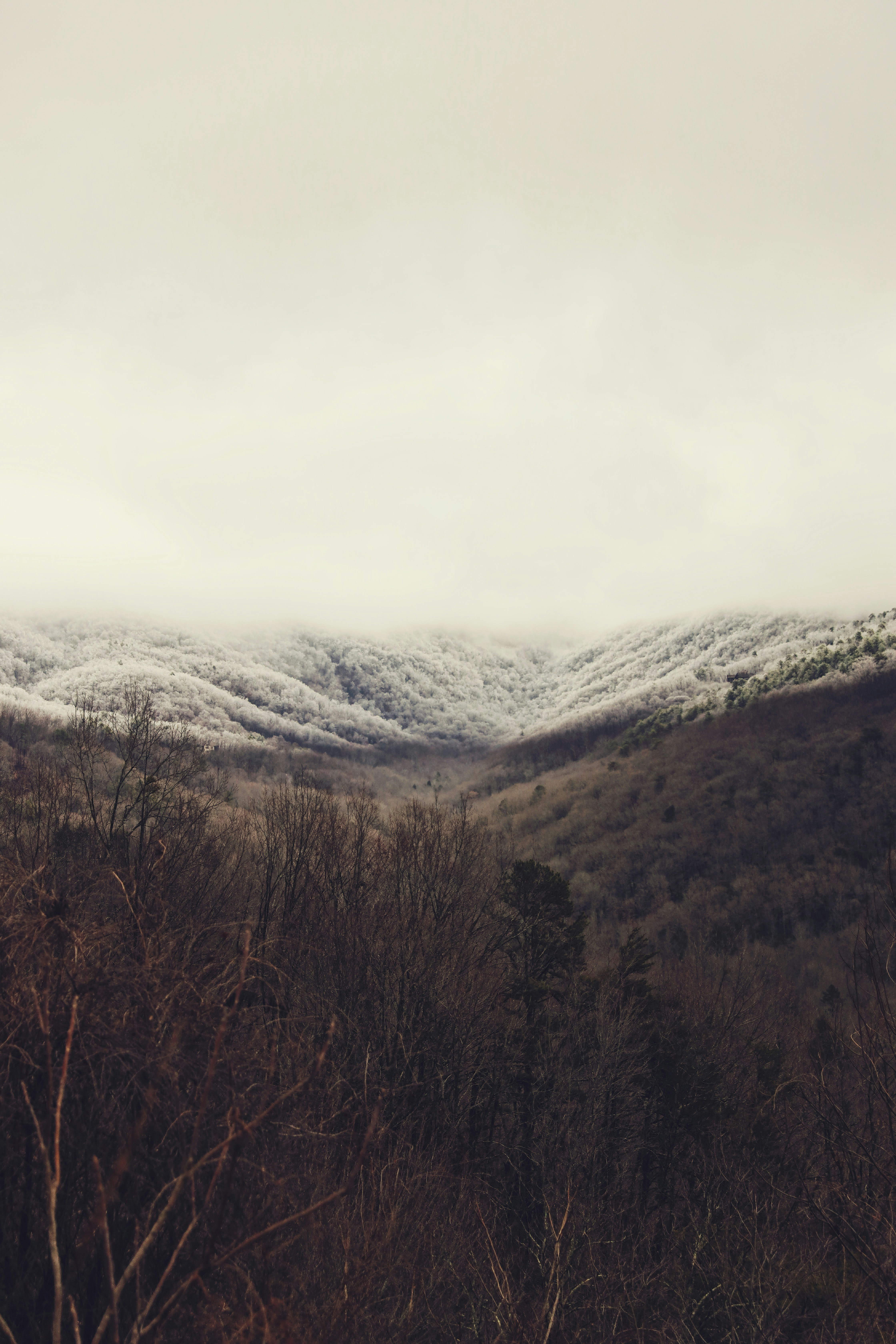 Snow-dusted Ridge at Dawn, Quiet Valleys Under Pale Sky