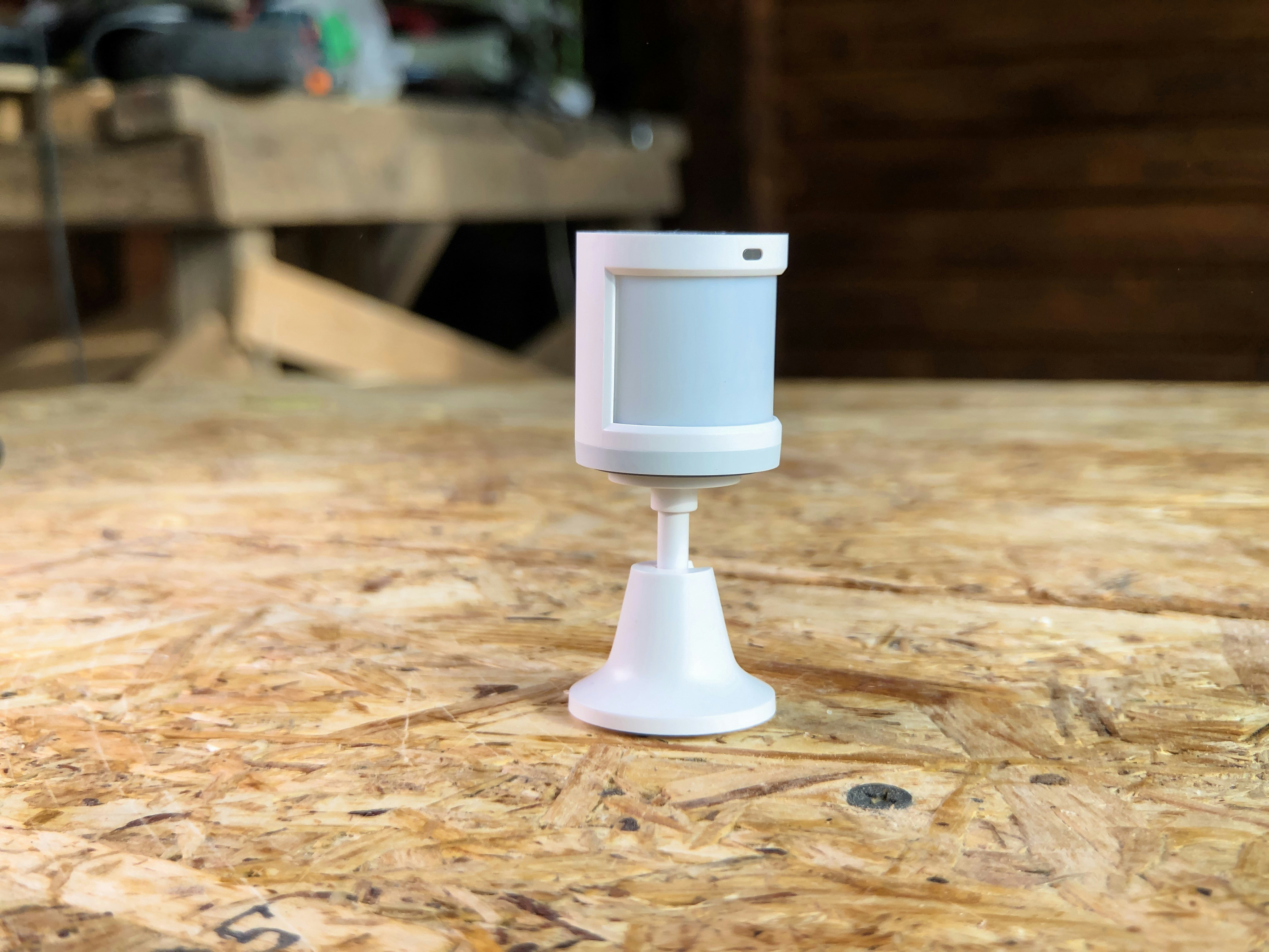 Minimal White Camera Mount Anchored on a Weathered Workbench