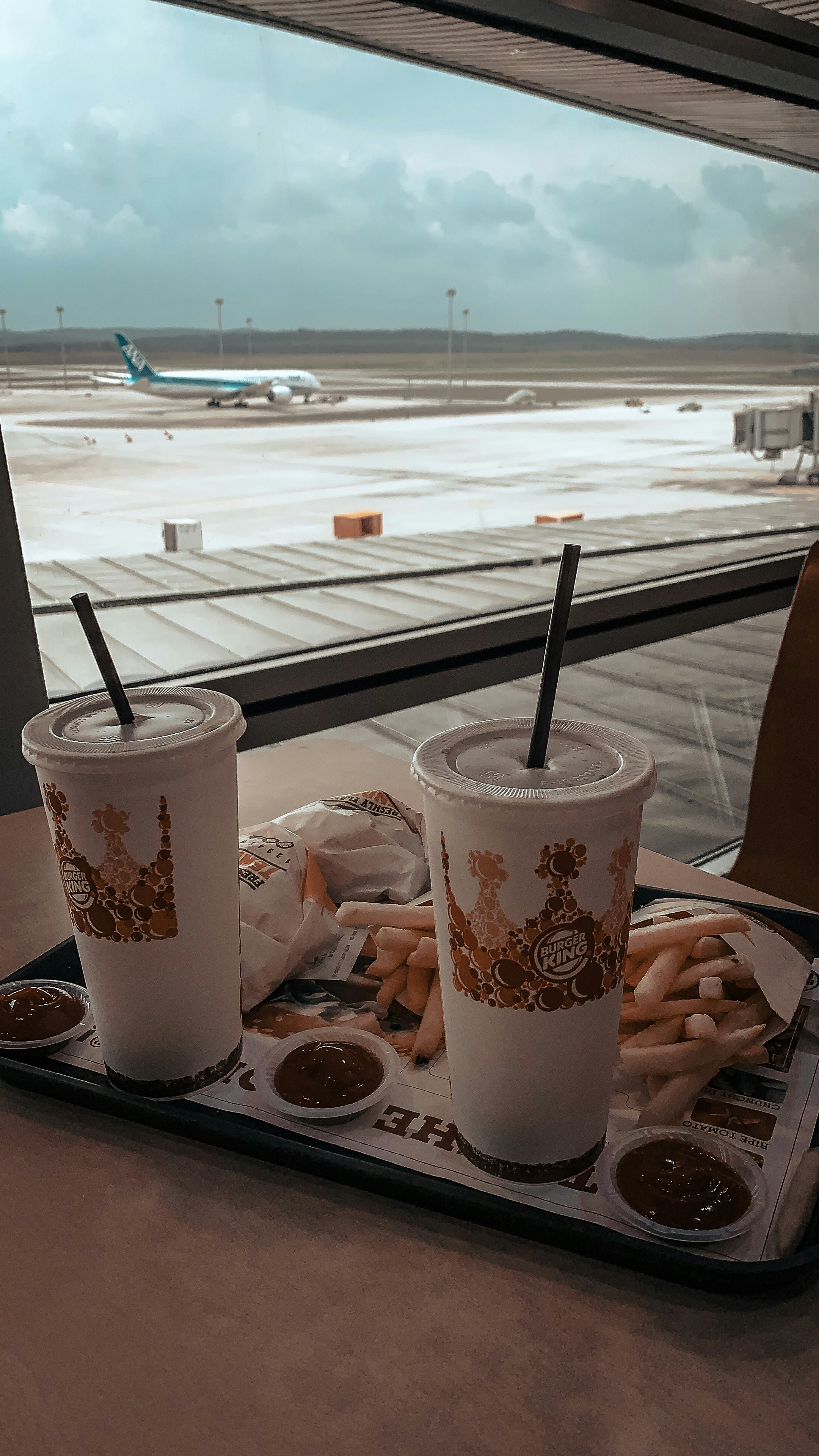 Terminal Snack Break: Fries, Two Cups, and a Quiet Runway View