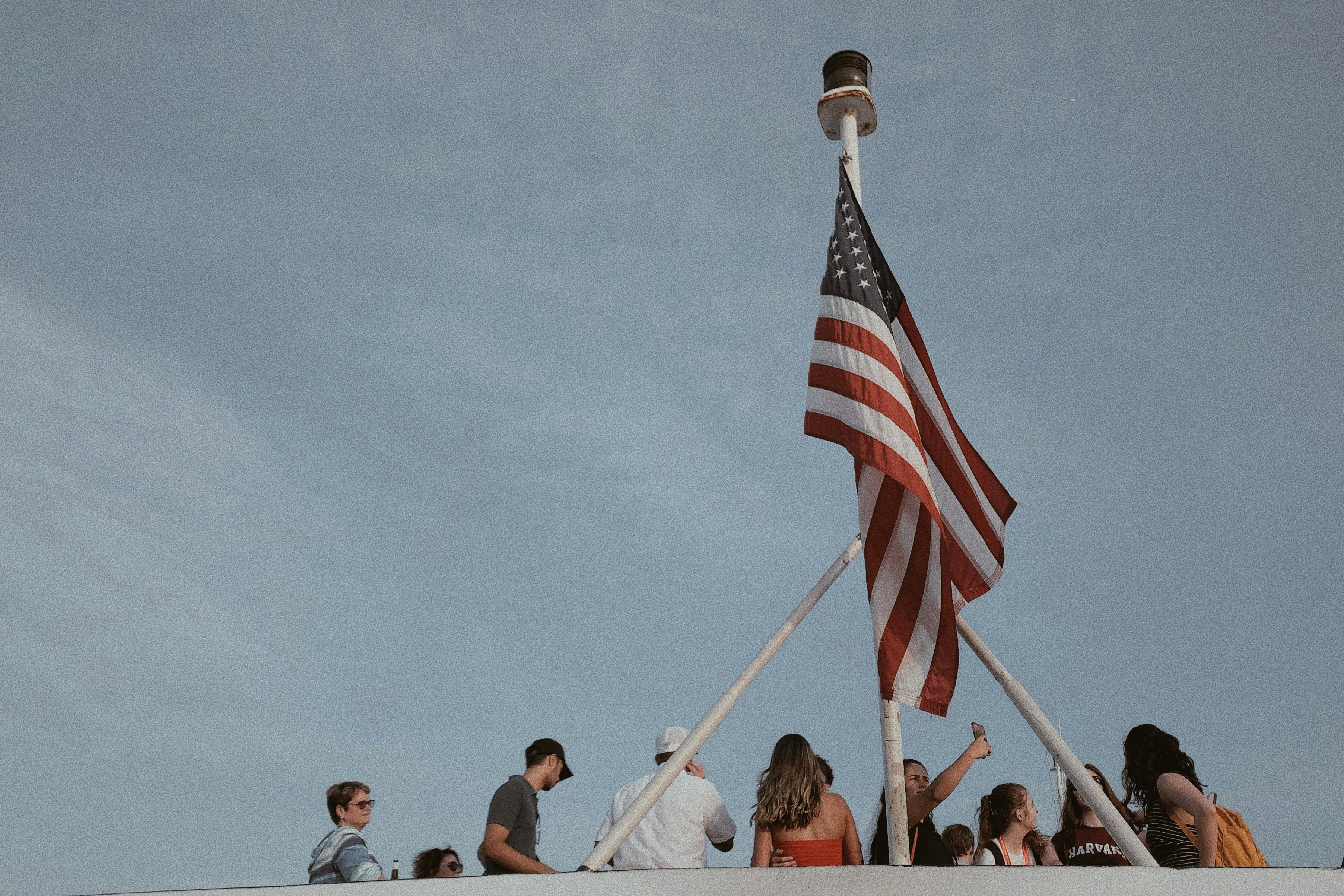 Flag Rising Over a Sunlit Deck