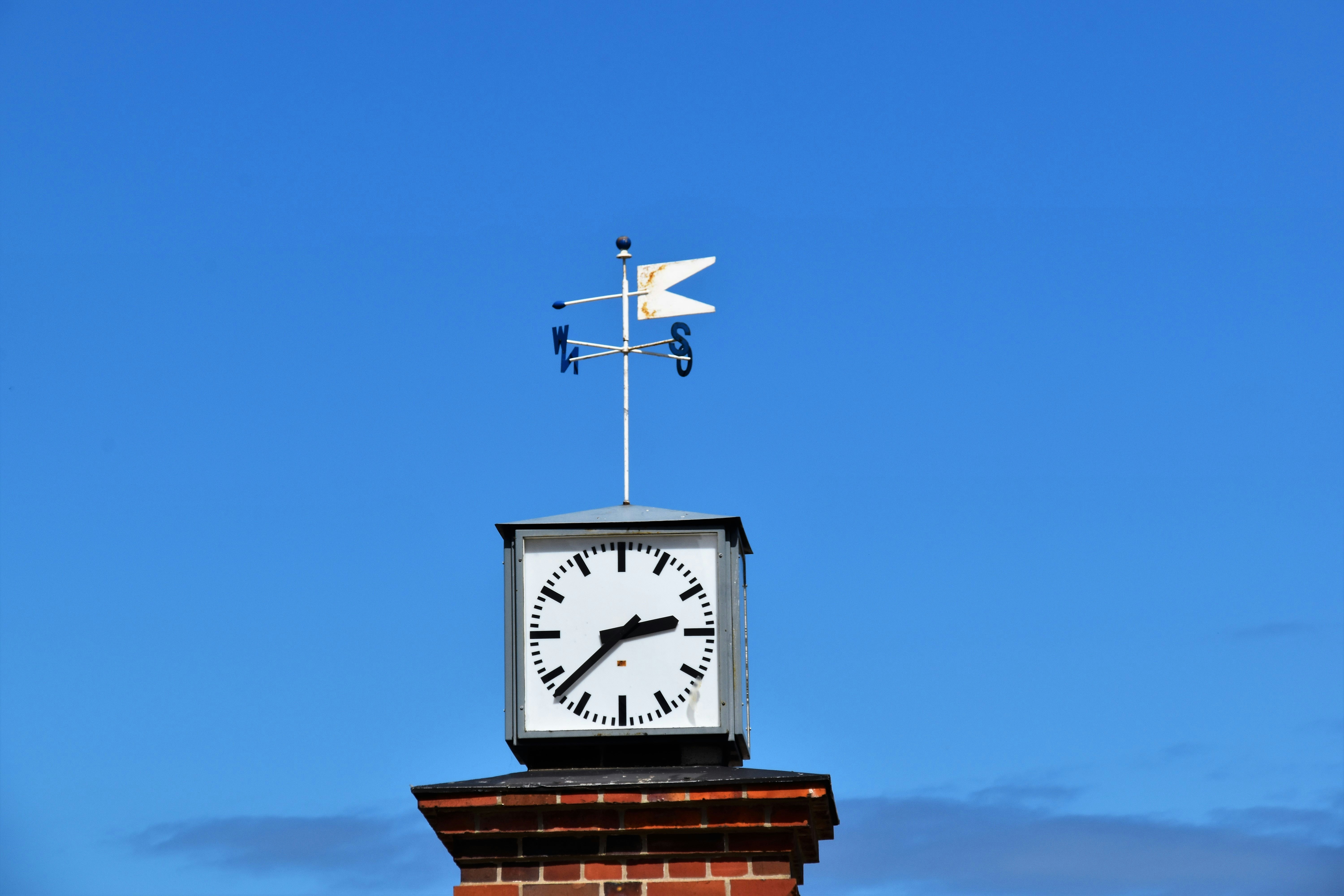 Timekeeper on a Brick Crown under a Clear Cerulean Sky