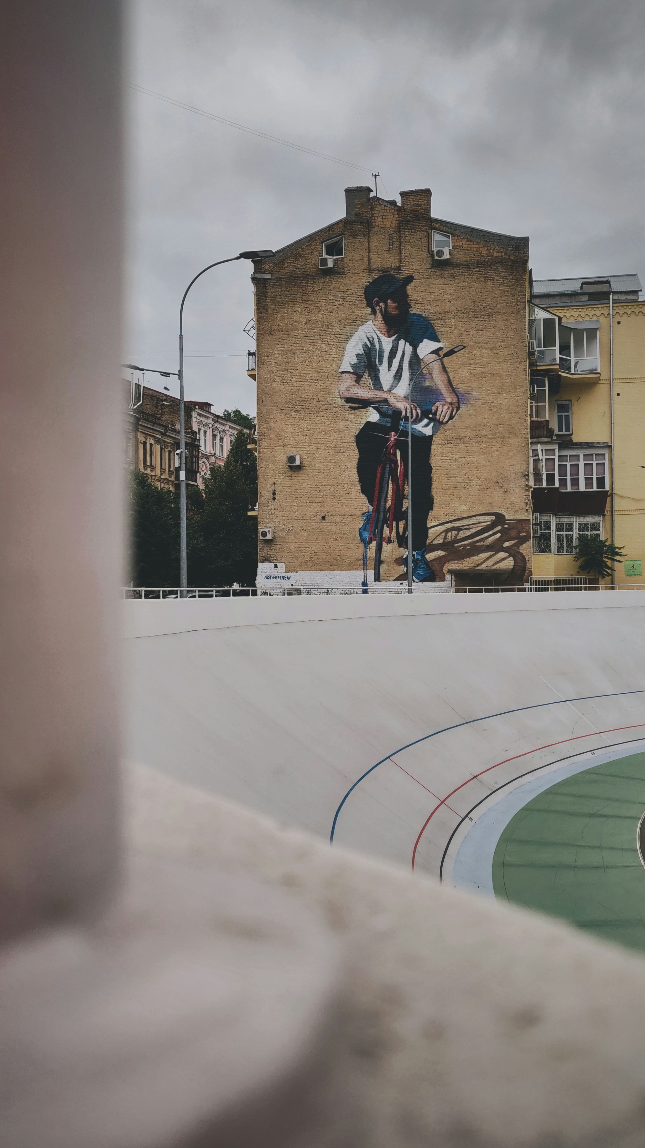 Bike-and-brick mural framed by concrete curves