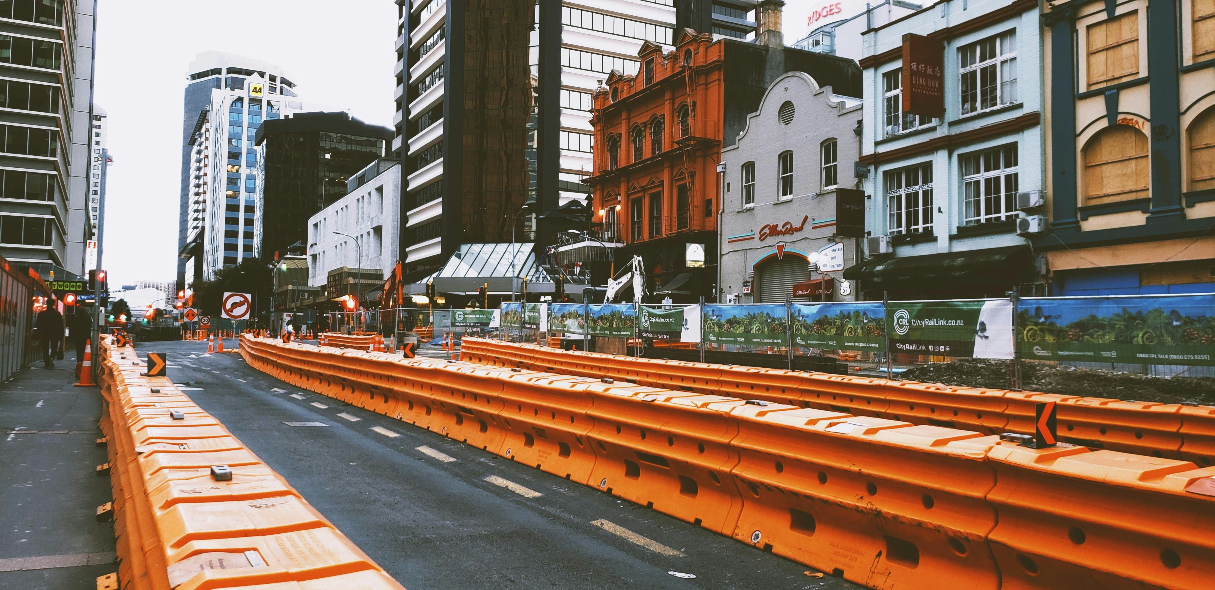 Yellow plastic road barriers across city buildings photo – Free 23 ...