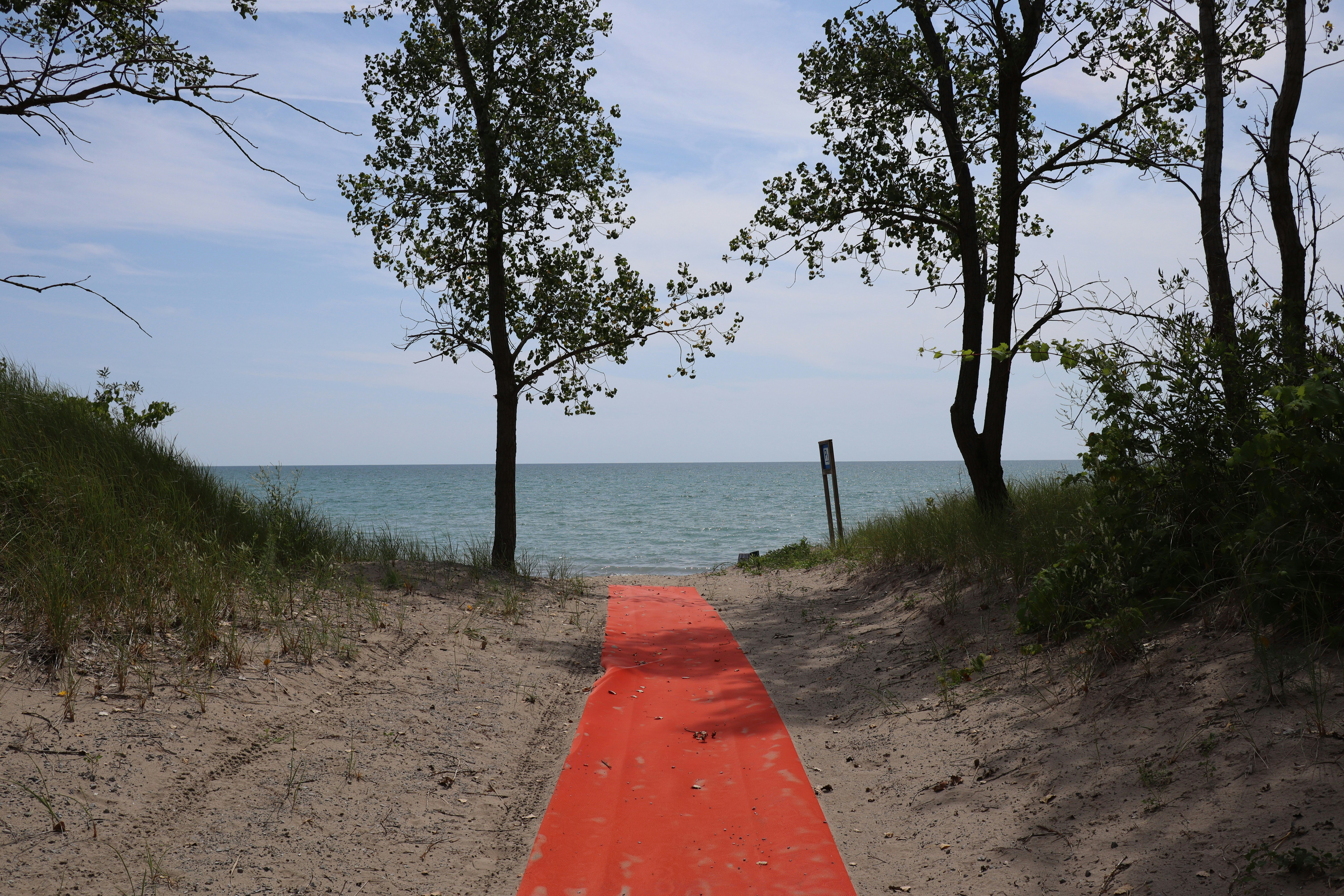 Red pathway leading body of water during daytime photo – Free Road ...