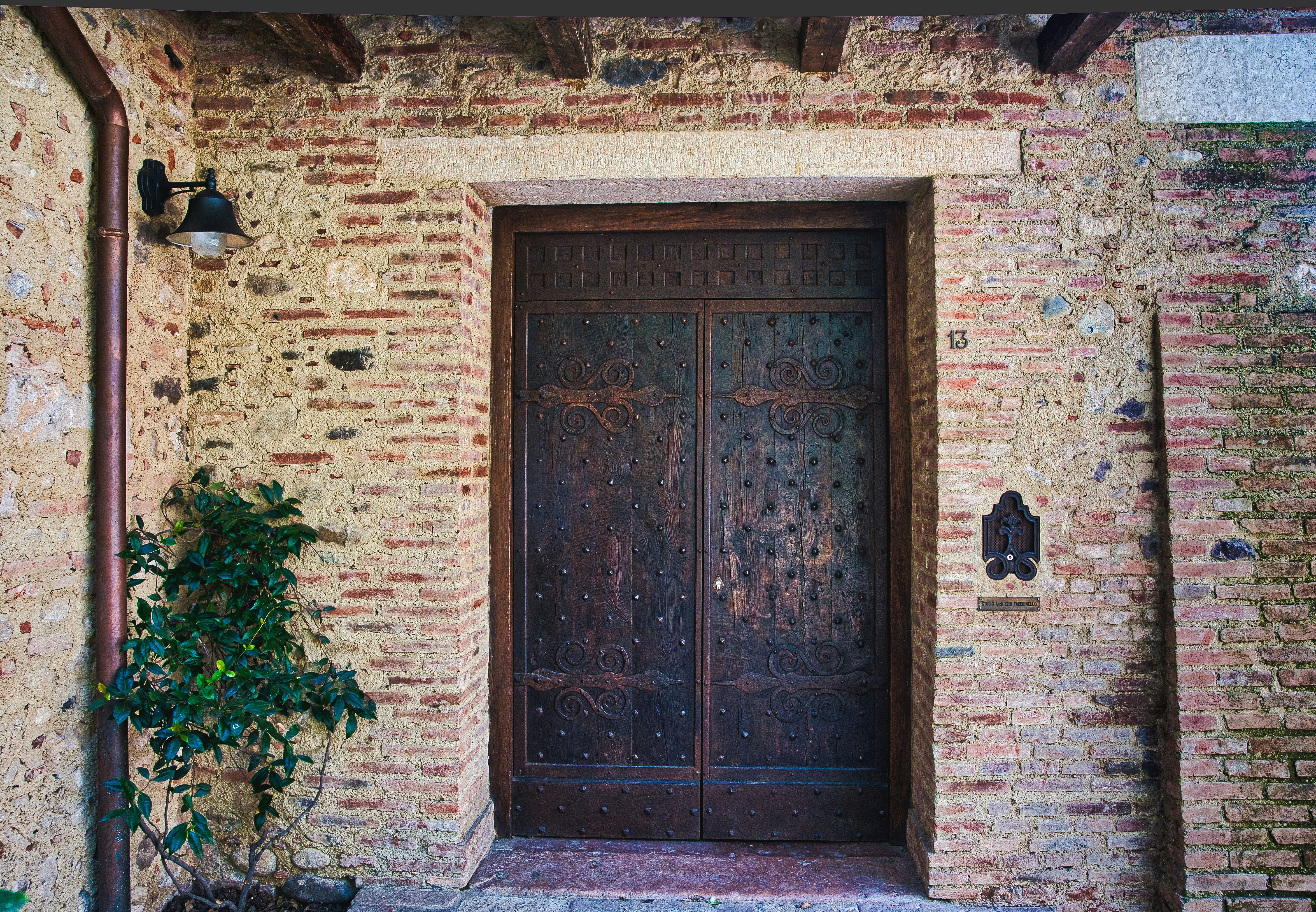 Iron Portal in Sun-Warmed Brick: A Quiet Courtyard Door