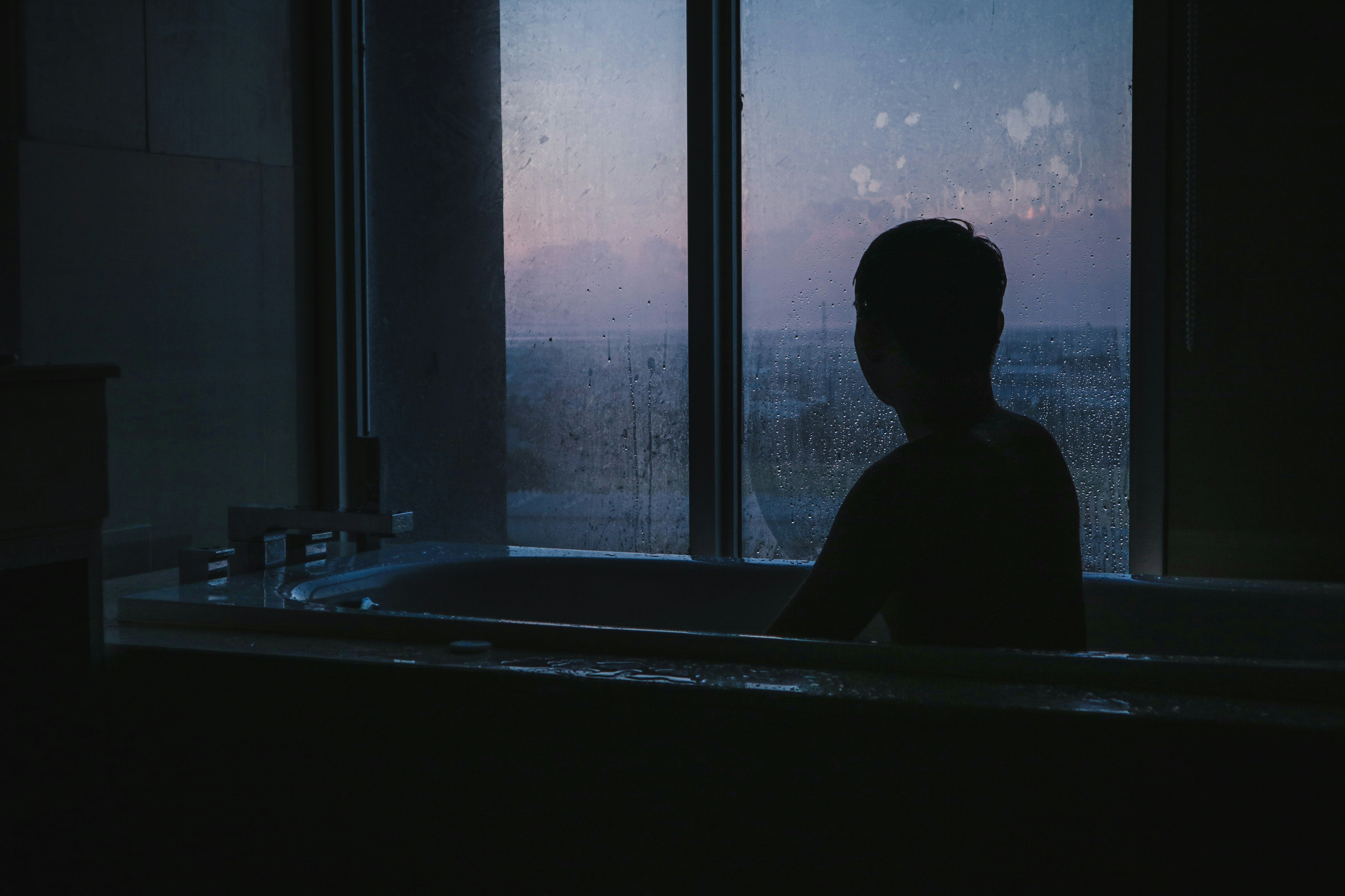 Silent Bath: A Solitary Figure in Blue Hour Tranquility