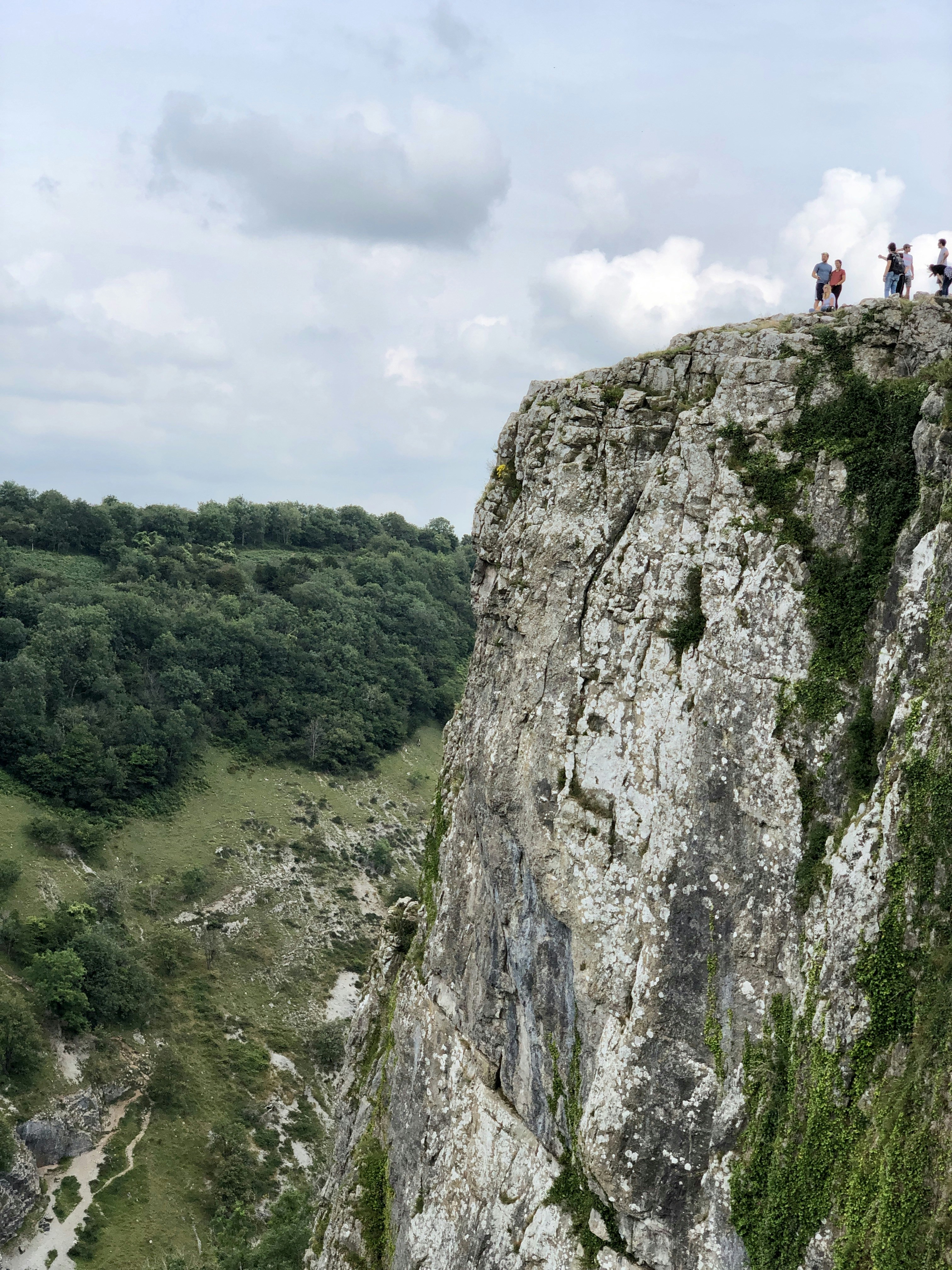 Edgebound Gaze: Climbers at the Crown of a Limestone Cliff