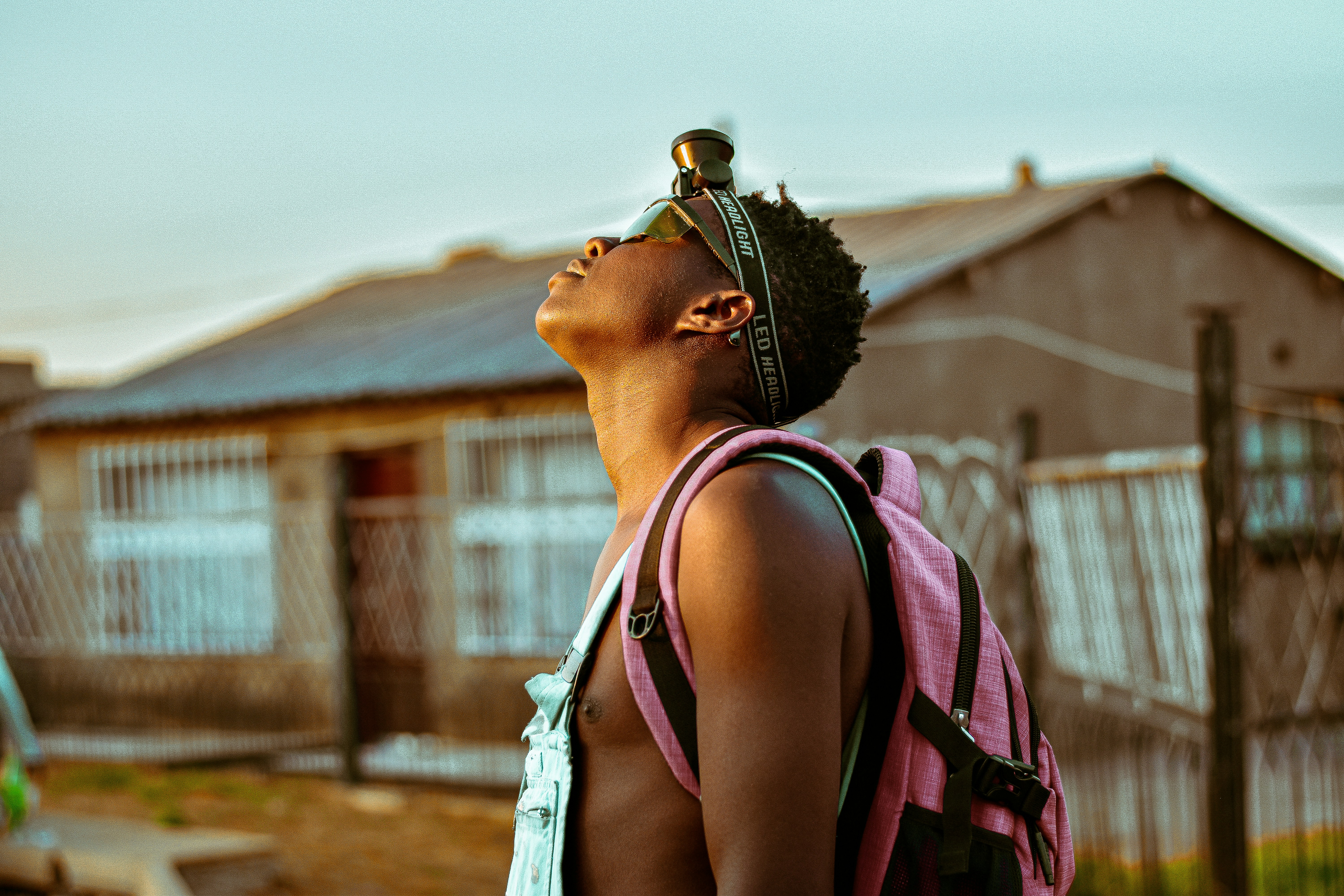 Topless man carrying pink backpack looking up photo – Free Person Image ...