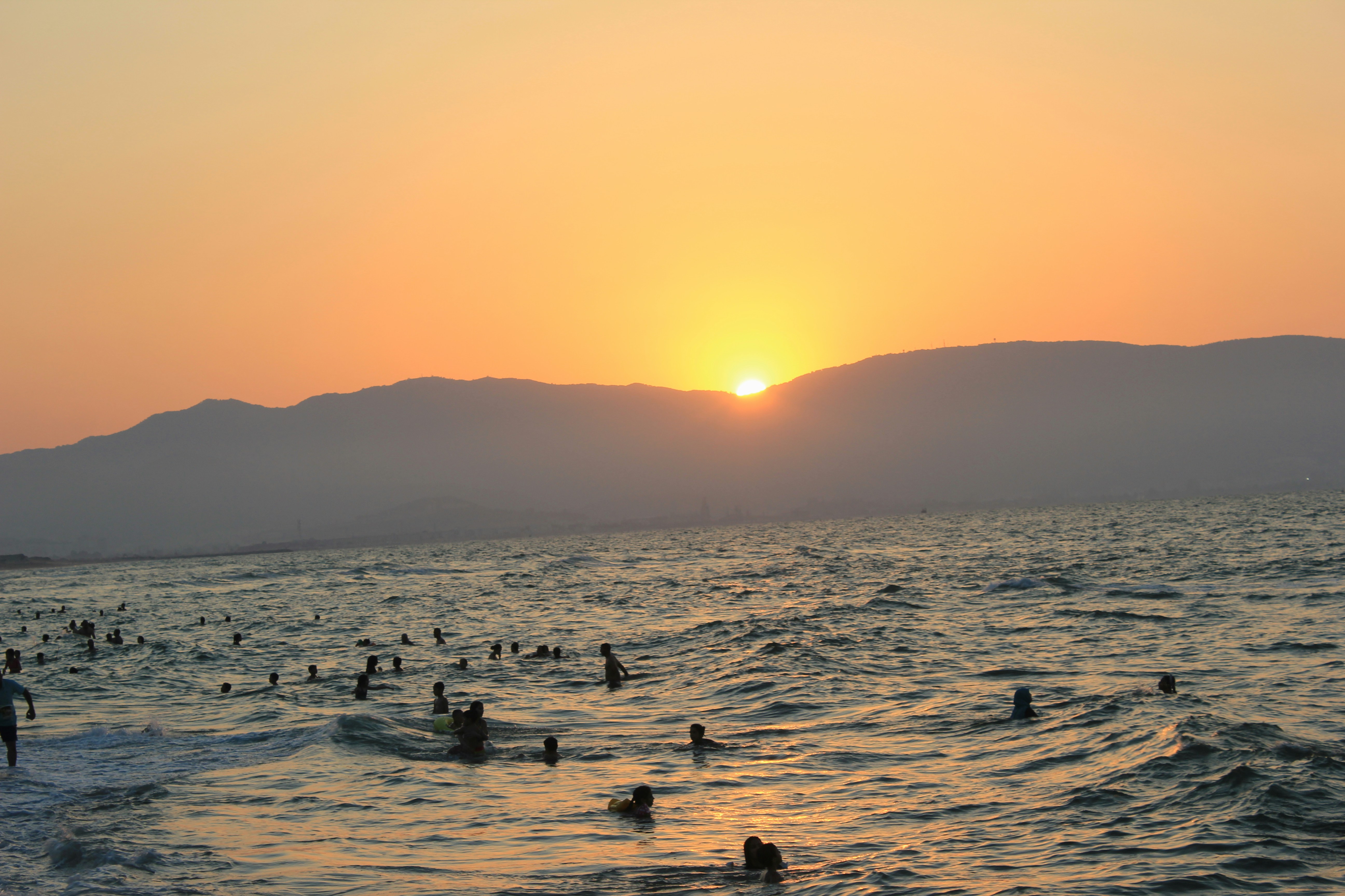 Horizon Ember: Sunset Silhouettes Over a Quiet Sea