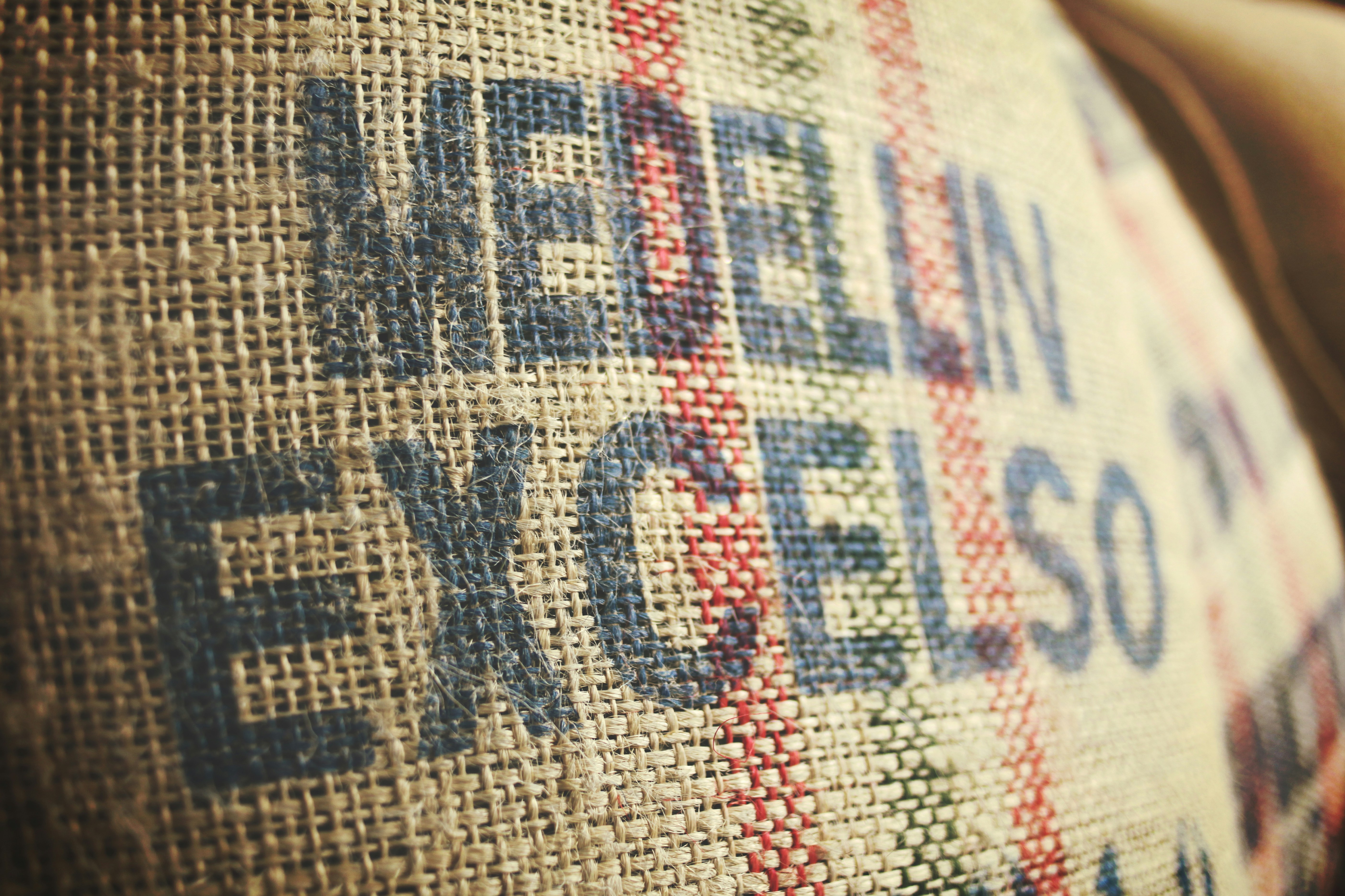 Close-up of a burlap coffee sack with 'Medellin Excelso' printed in bold letters.