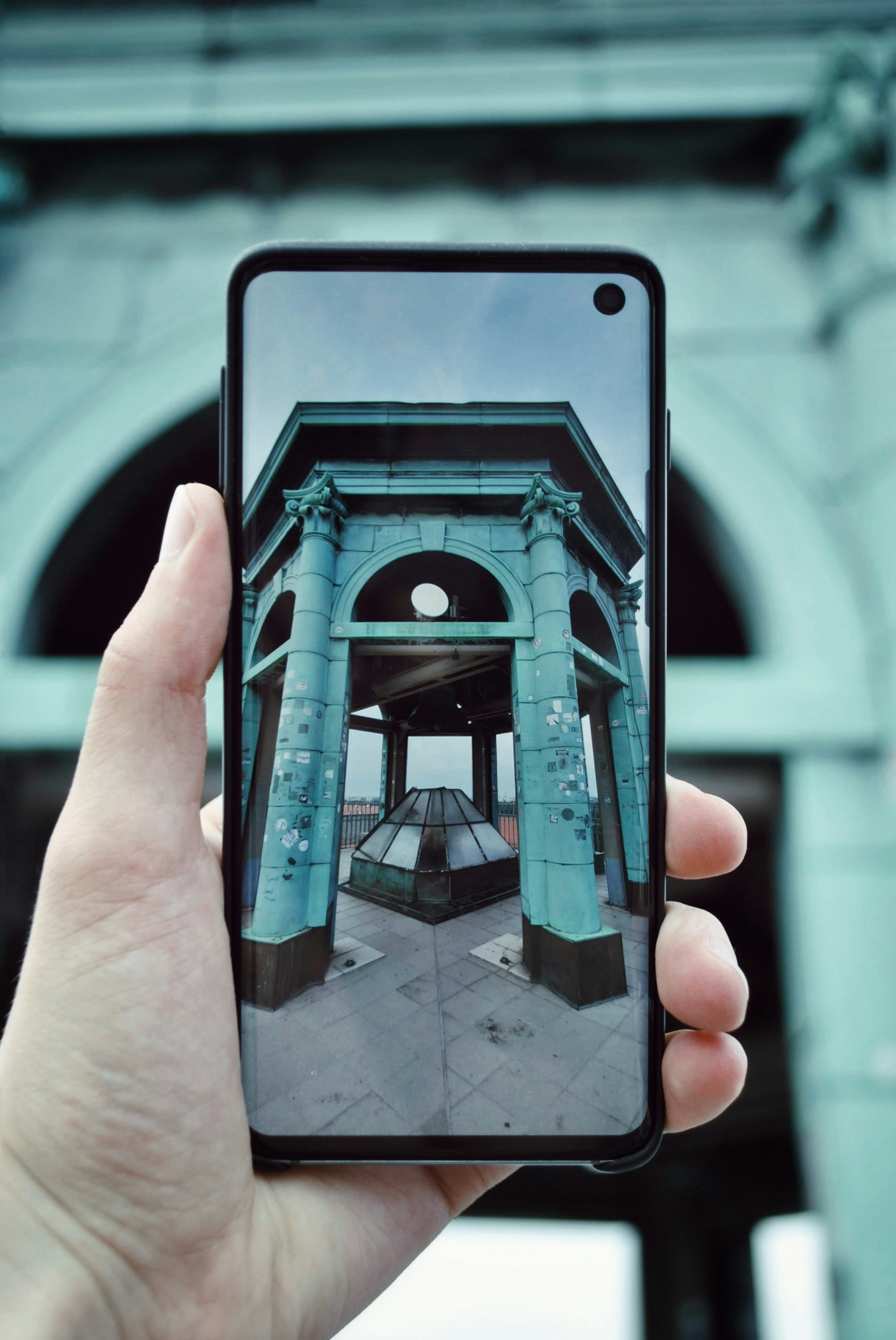 Through a Glassy Portal: Architectural Fragments Framed by a Handheld Screen