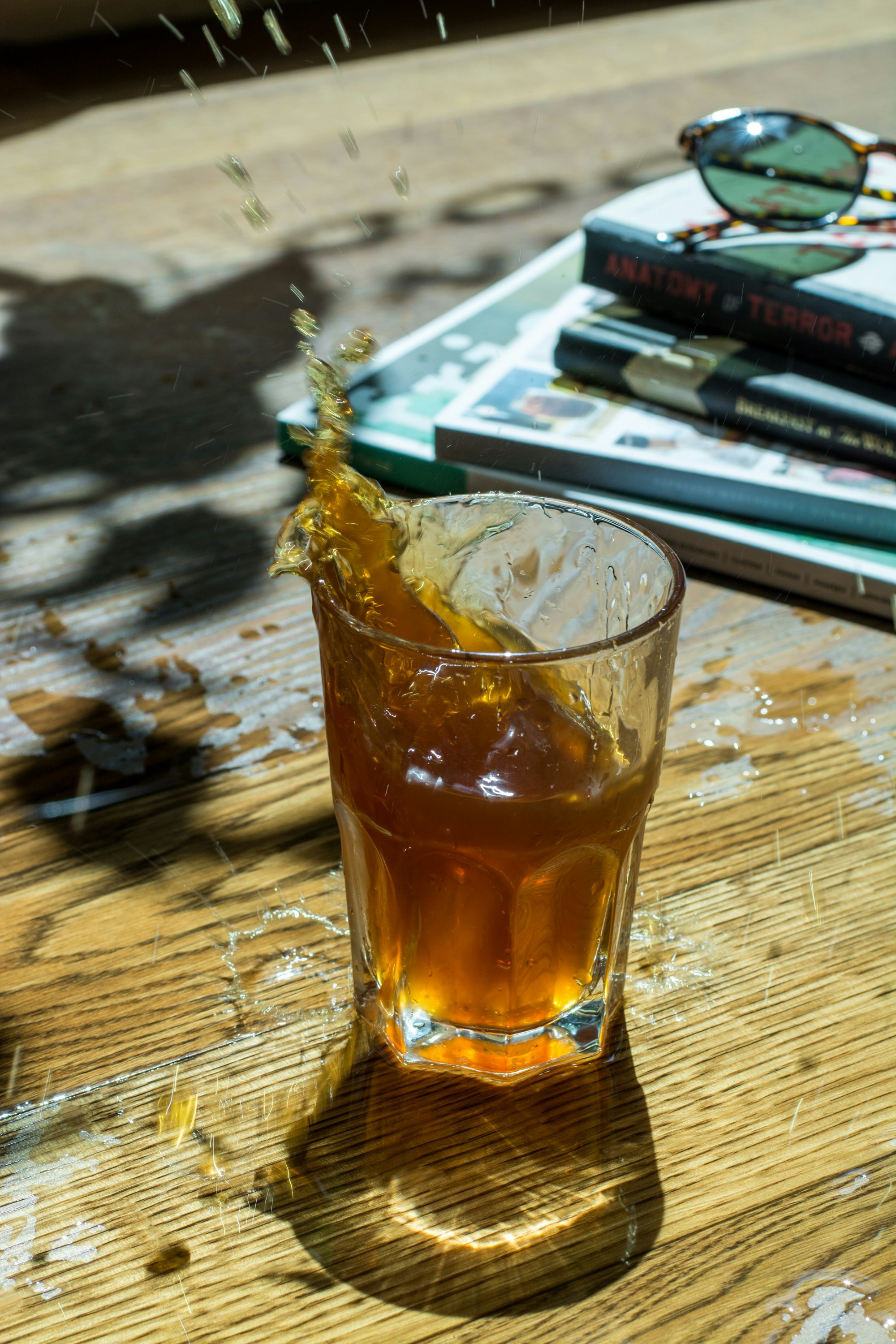 Amber Splash on a Sunlit Wooden Table