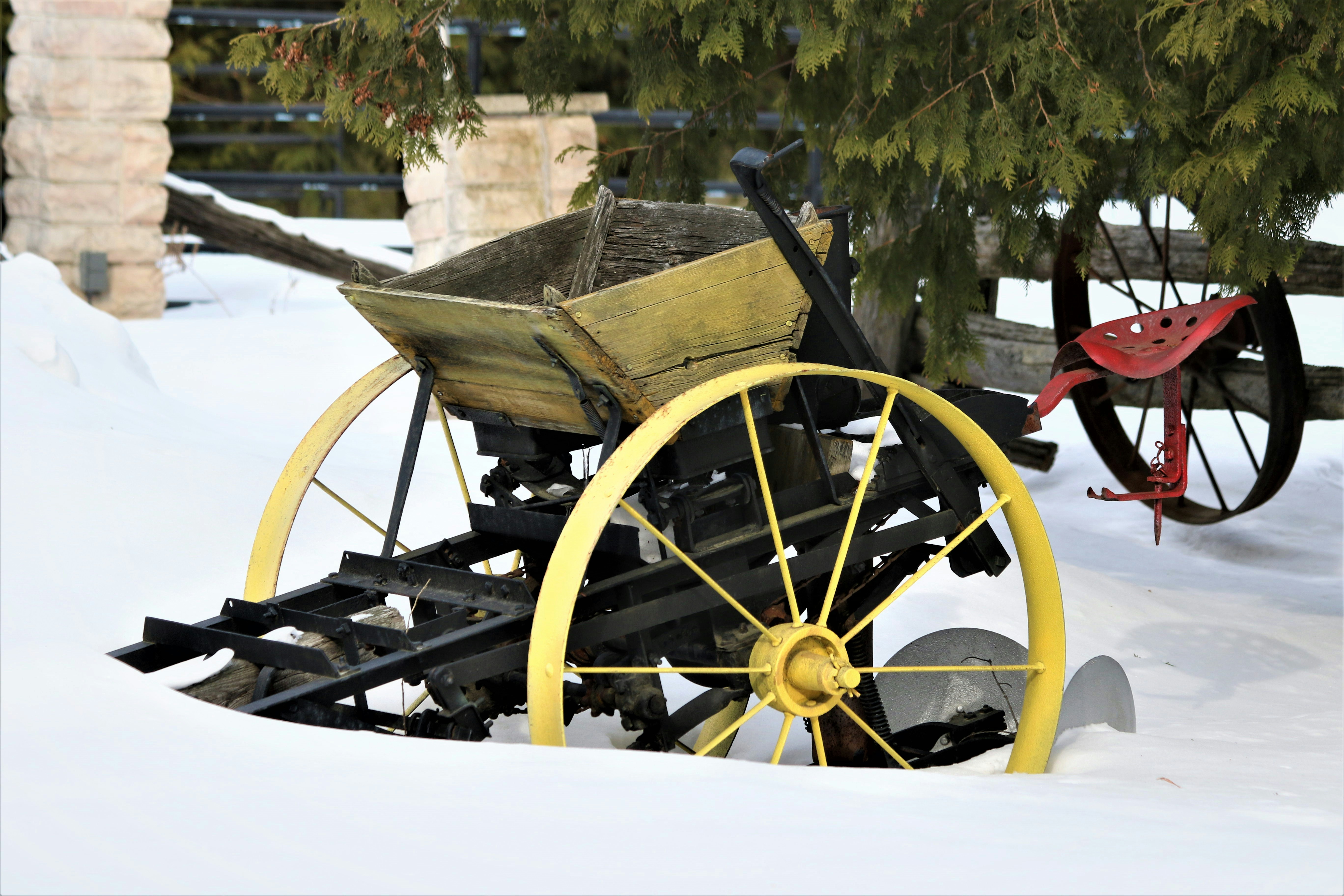 Yellow-Wheeled Cart in Fresh Snow