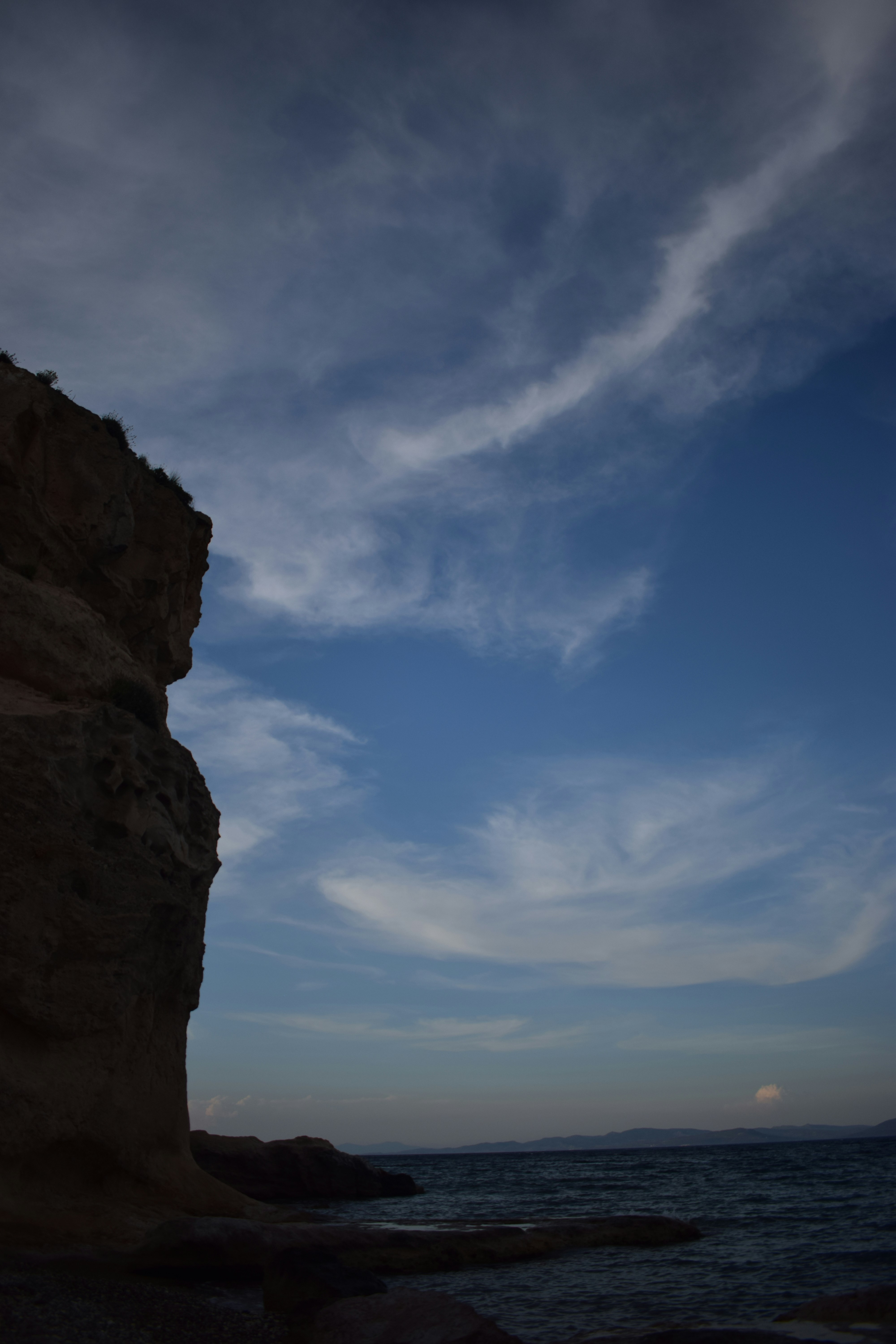Limestone Sentinel Against a Calm Blue Expanse
