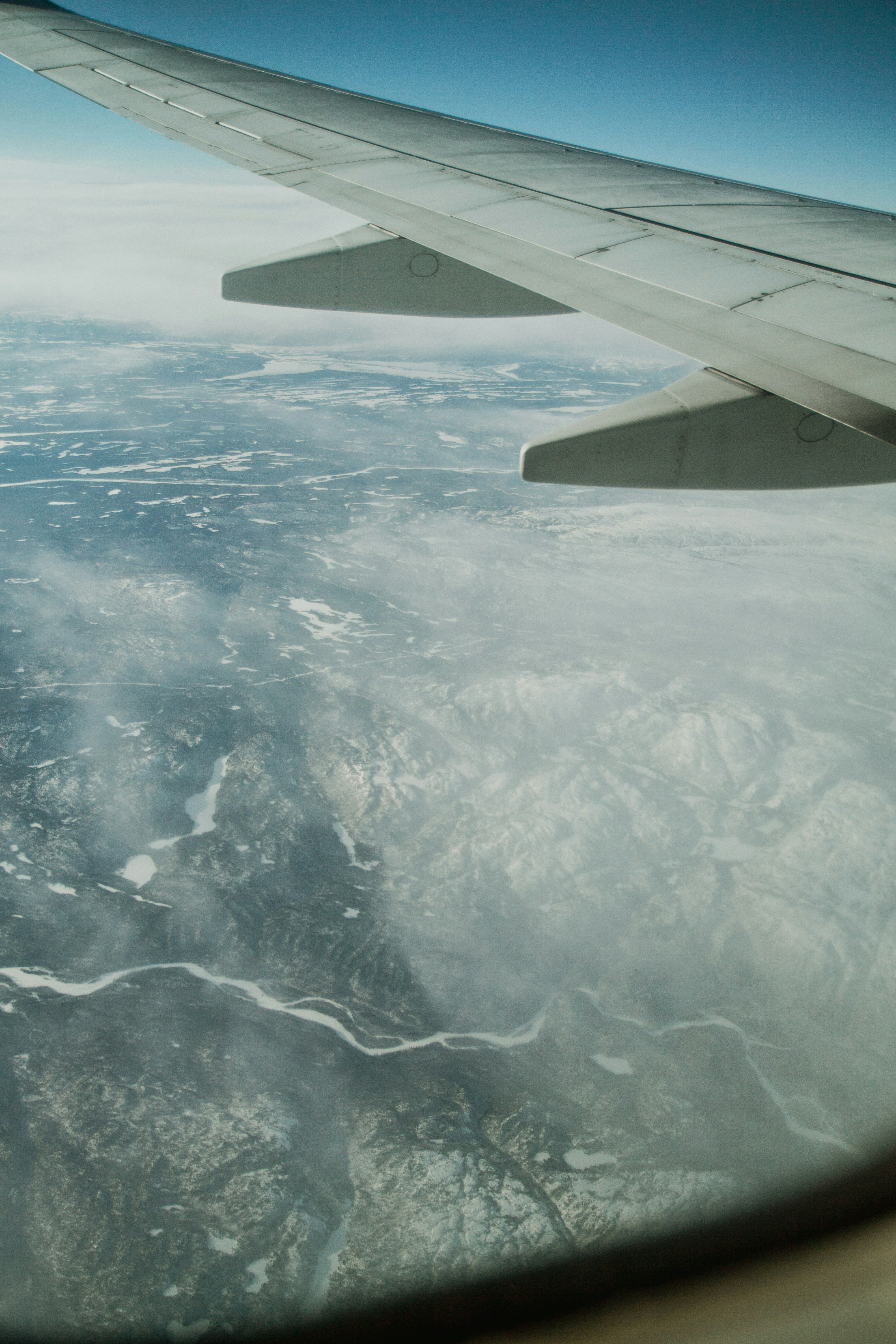 Window Seat Over the Alpine Expanse: A Wing's Quiet Flight