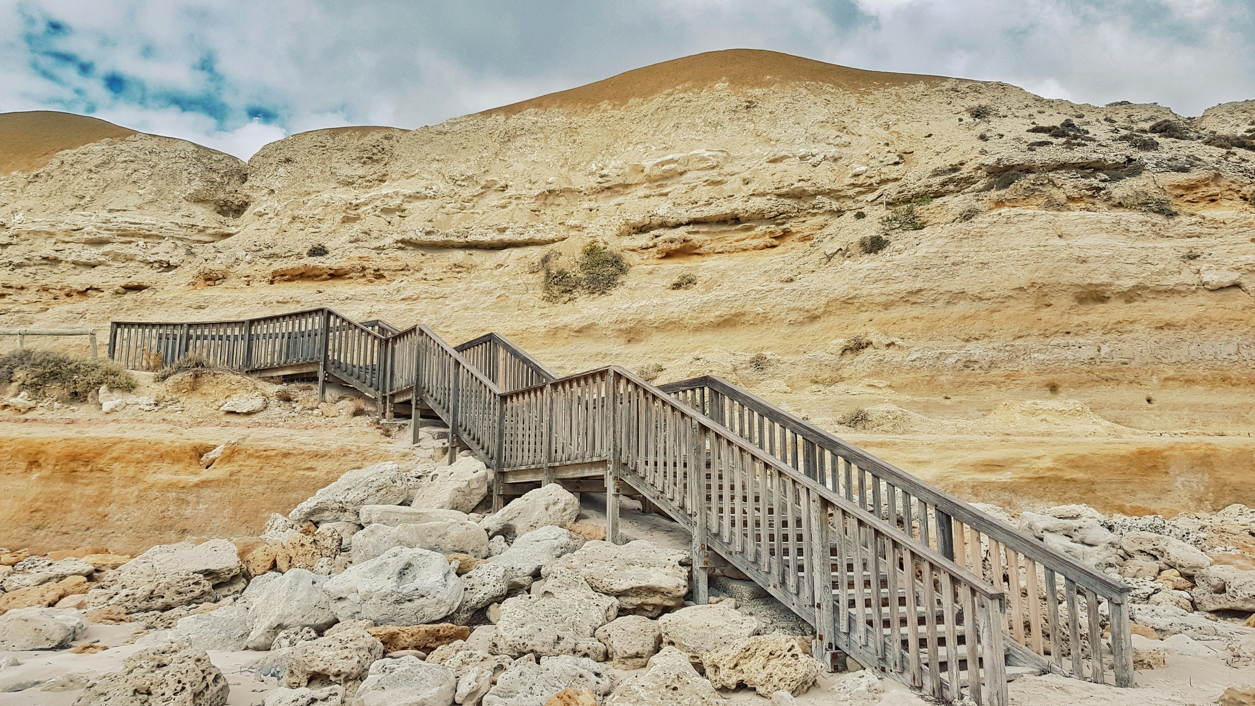 Wind-Worn Staircase Carving a Path Through Sunlit Limestone