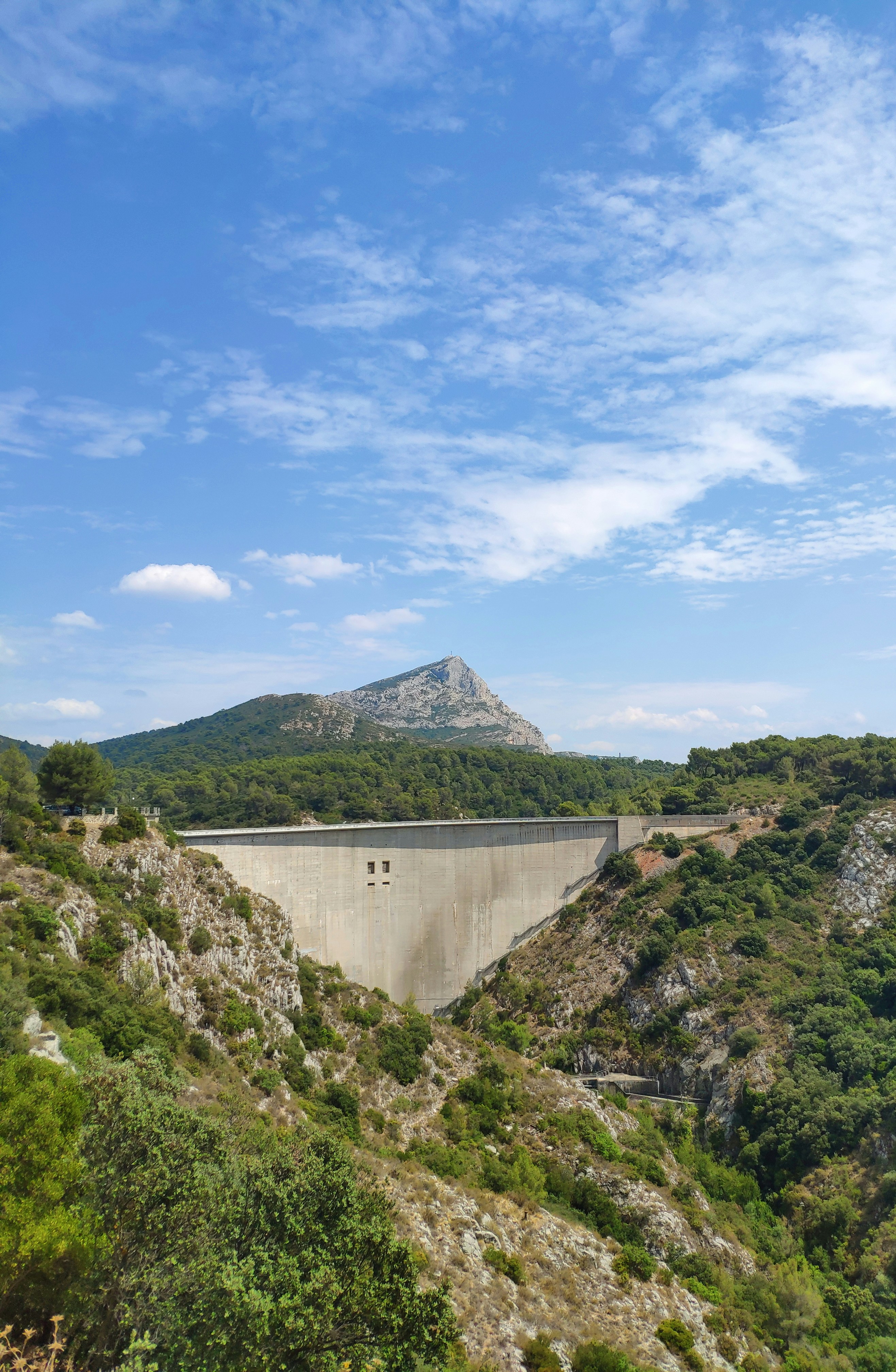 A large concrete structure on a mountain side photo – Free Blue Image ...