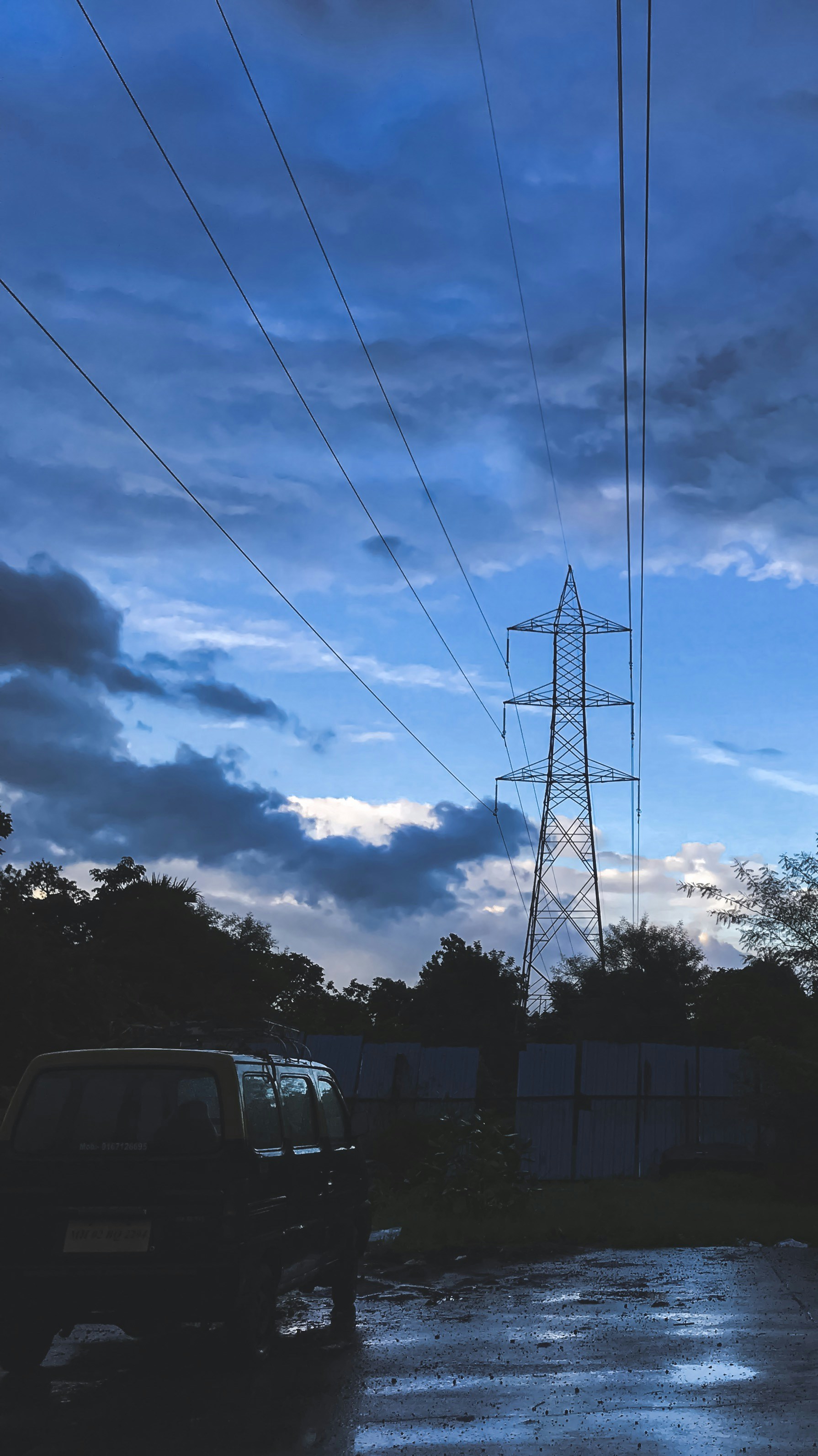 Blue Hour Lattice: Transmission Tower Framed by Power Lines