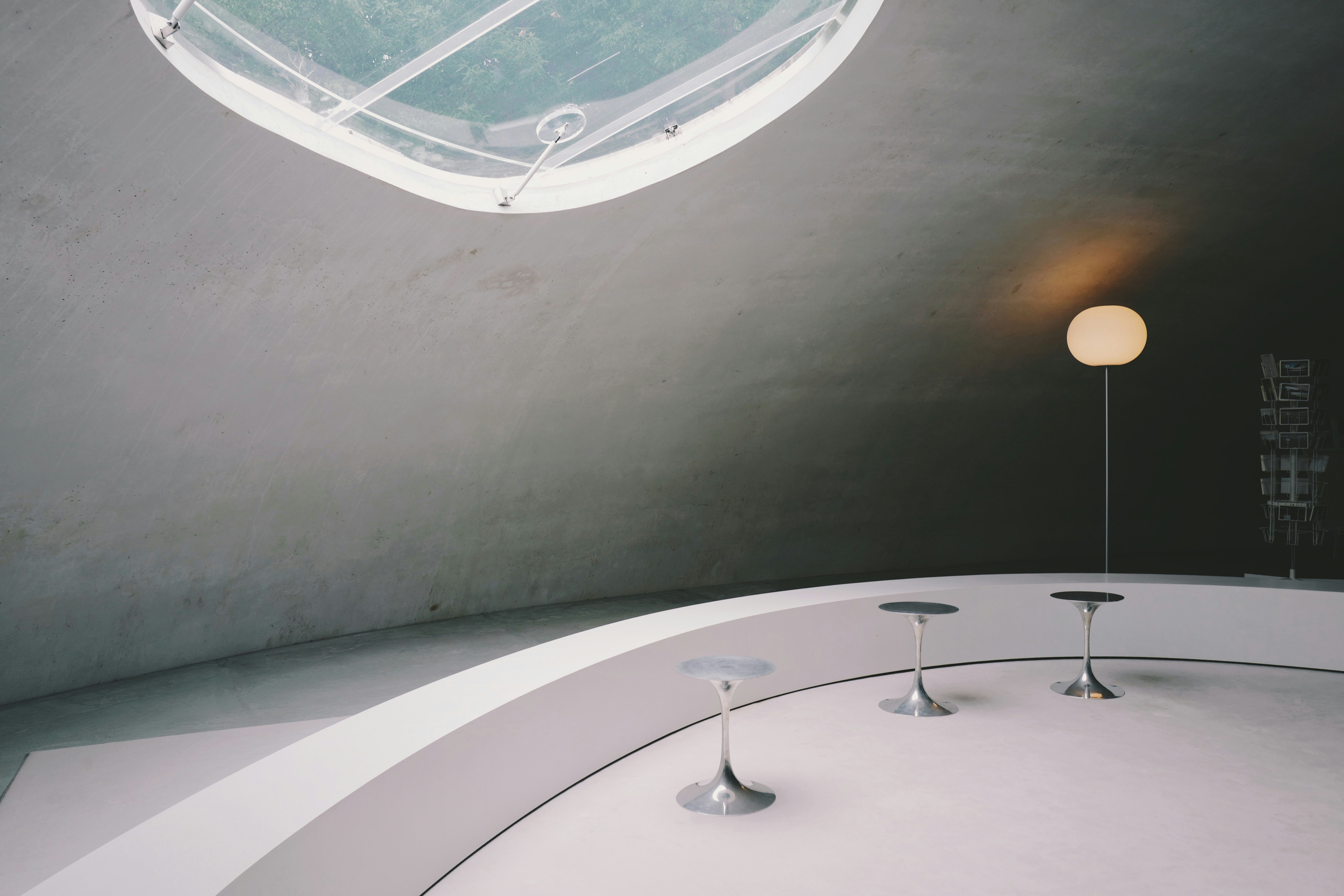 A circular room with a skylight and two tables photo – Free Building ...