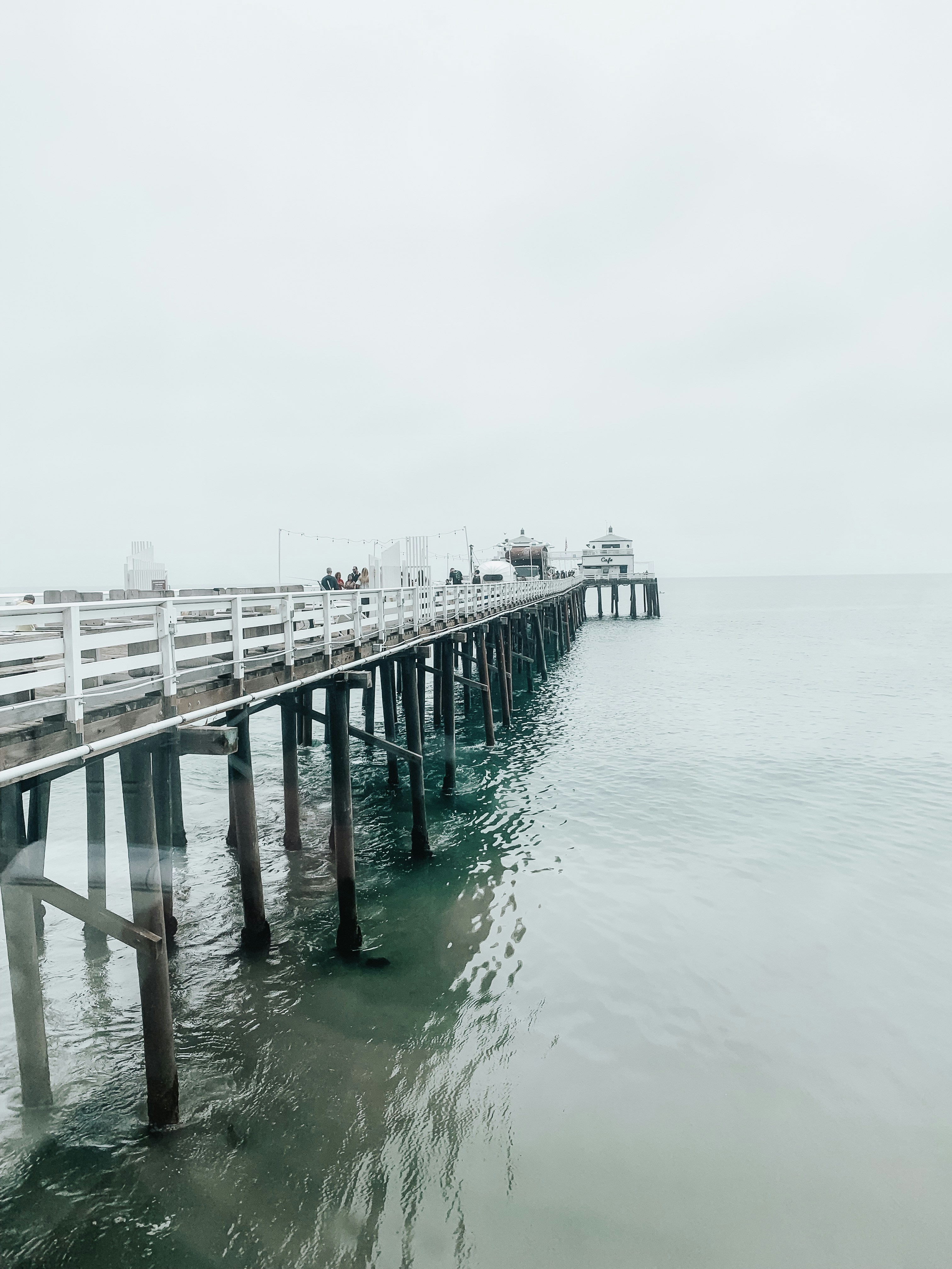 A long wooden pier stretching out into the ocean photo – Free Grey ...