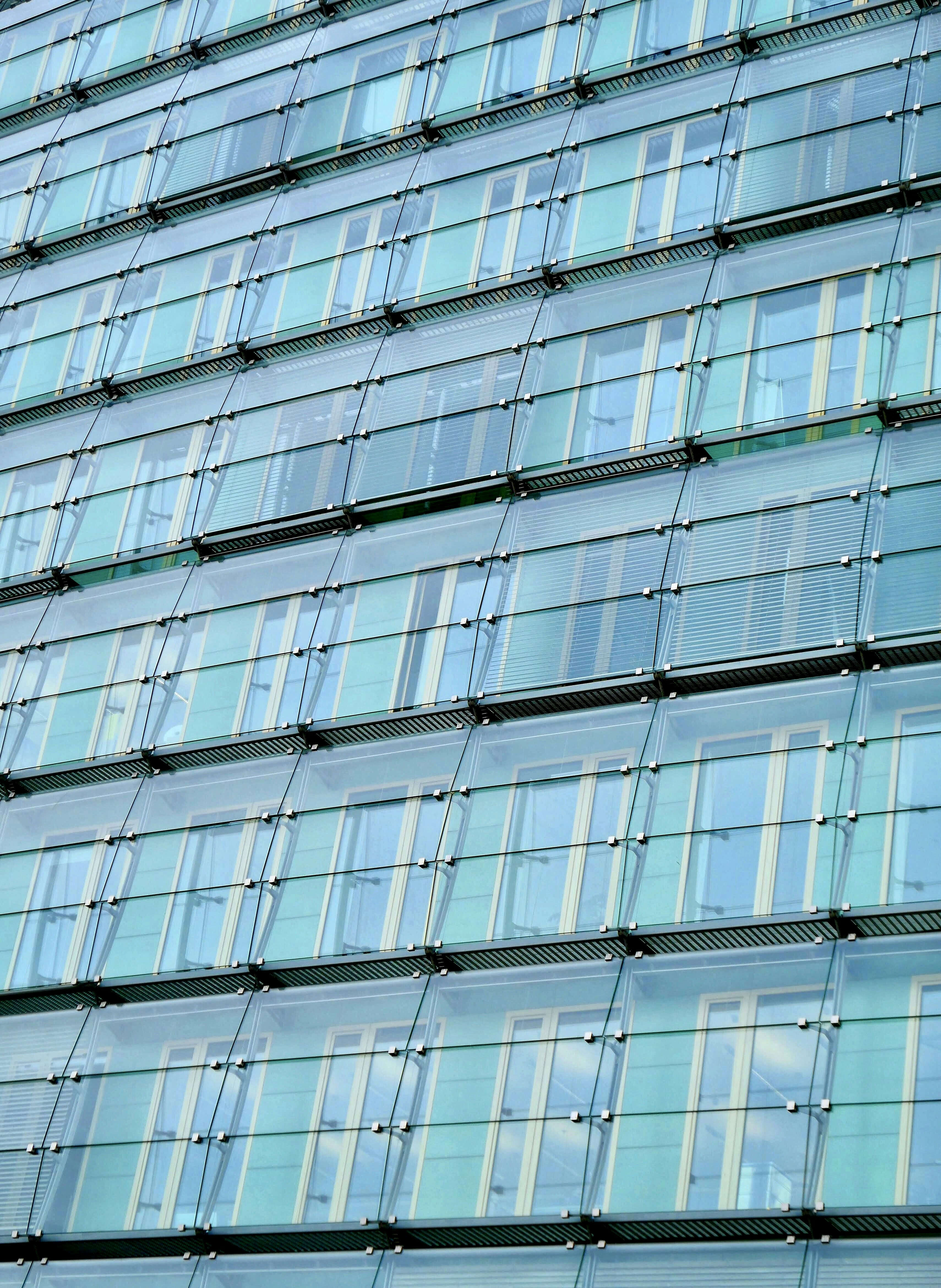 Close-up of a contemporary building's glass facade, showcasing the intricate arrangement of windows and structural elements.