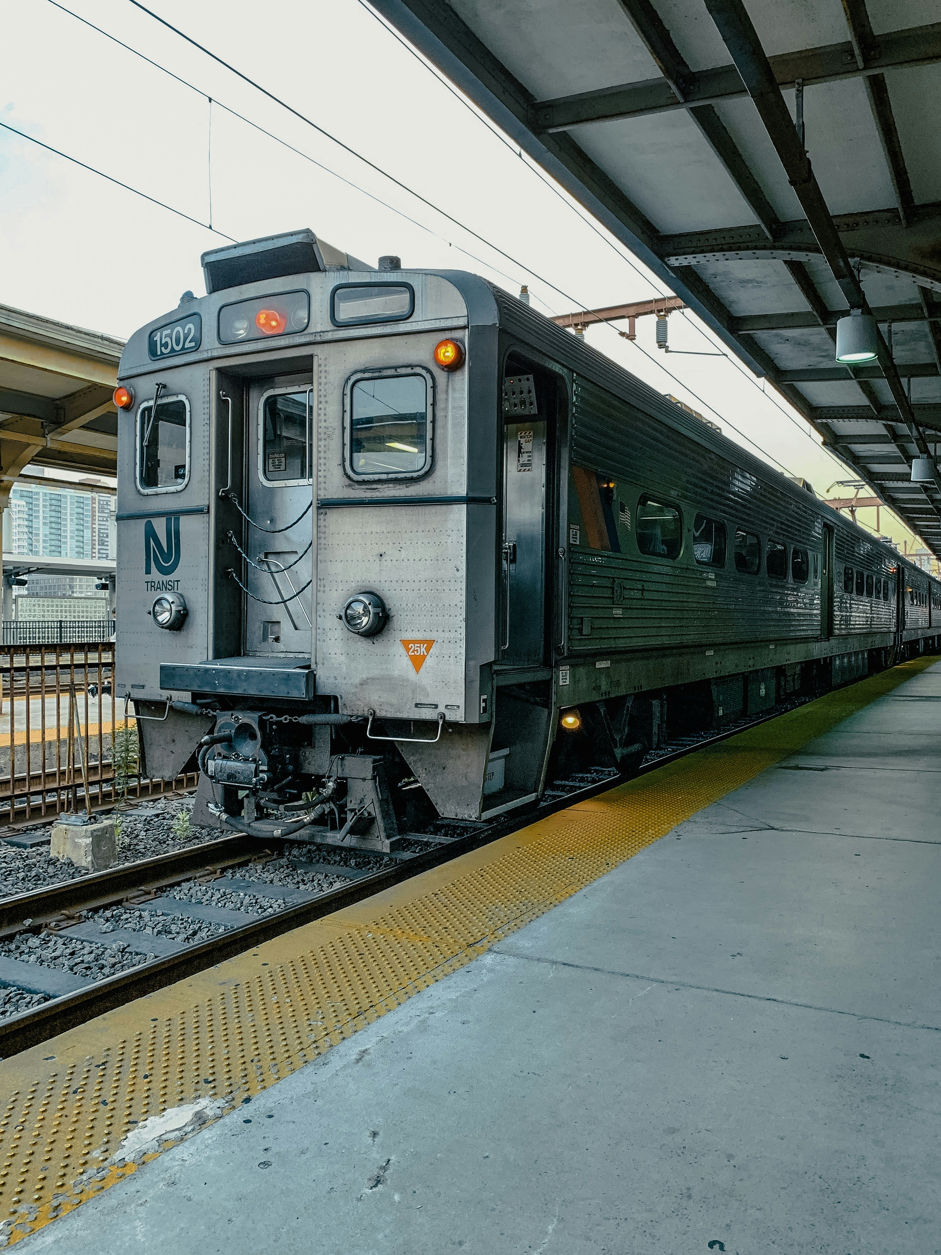 Platform Quiet: The Silver Transit Car Resting Along the Platform Edge