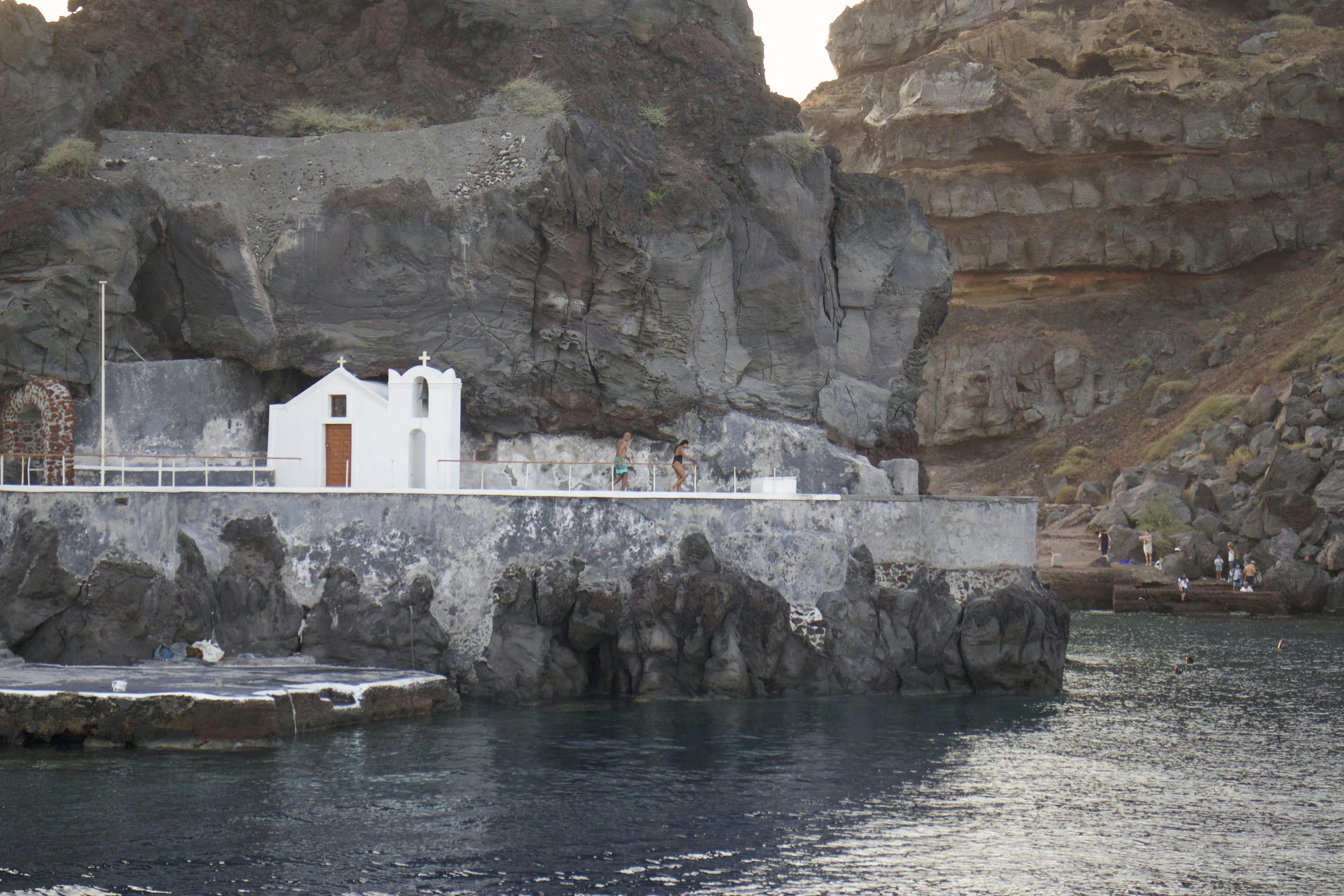 White Chapel by the Sea Against Cliffside Ridge
