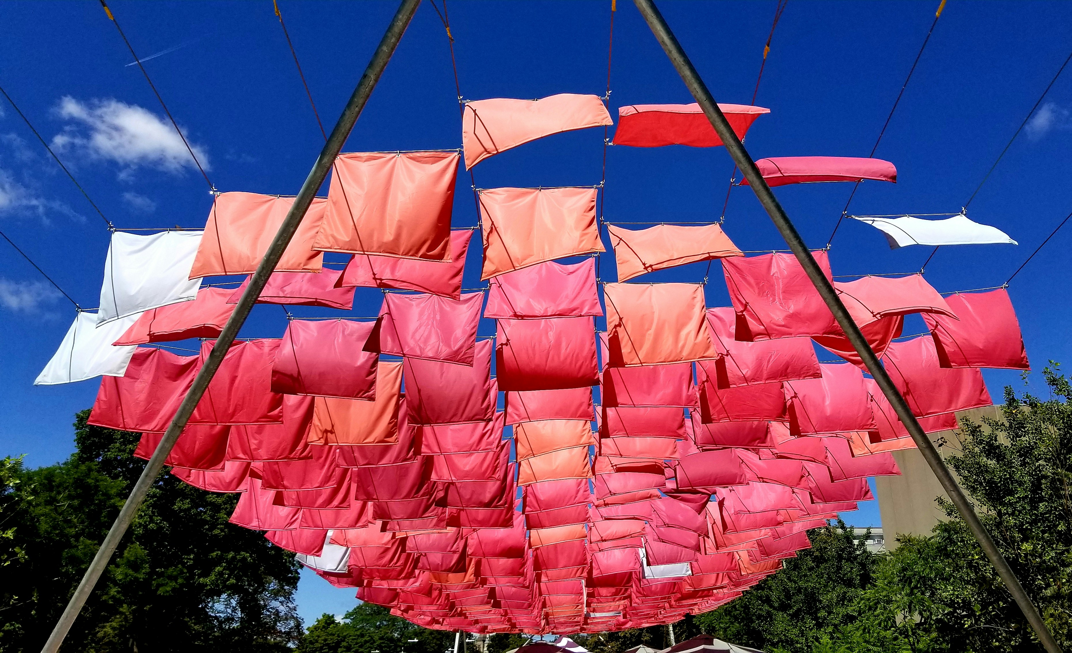 A group of red and white flags hanging from wires photo – Free ...