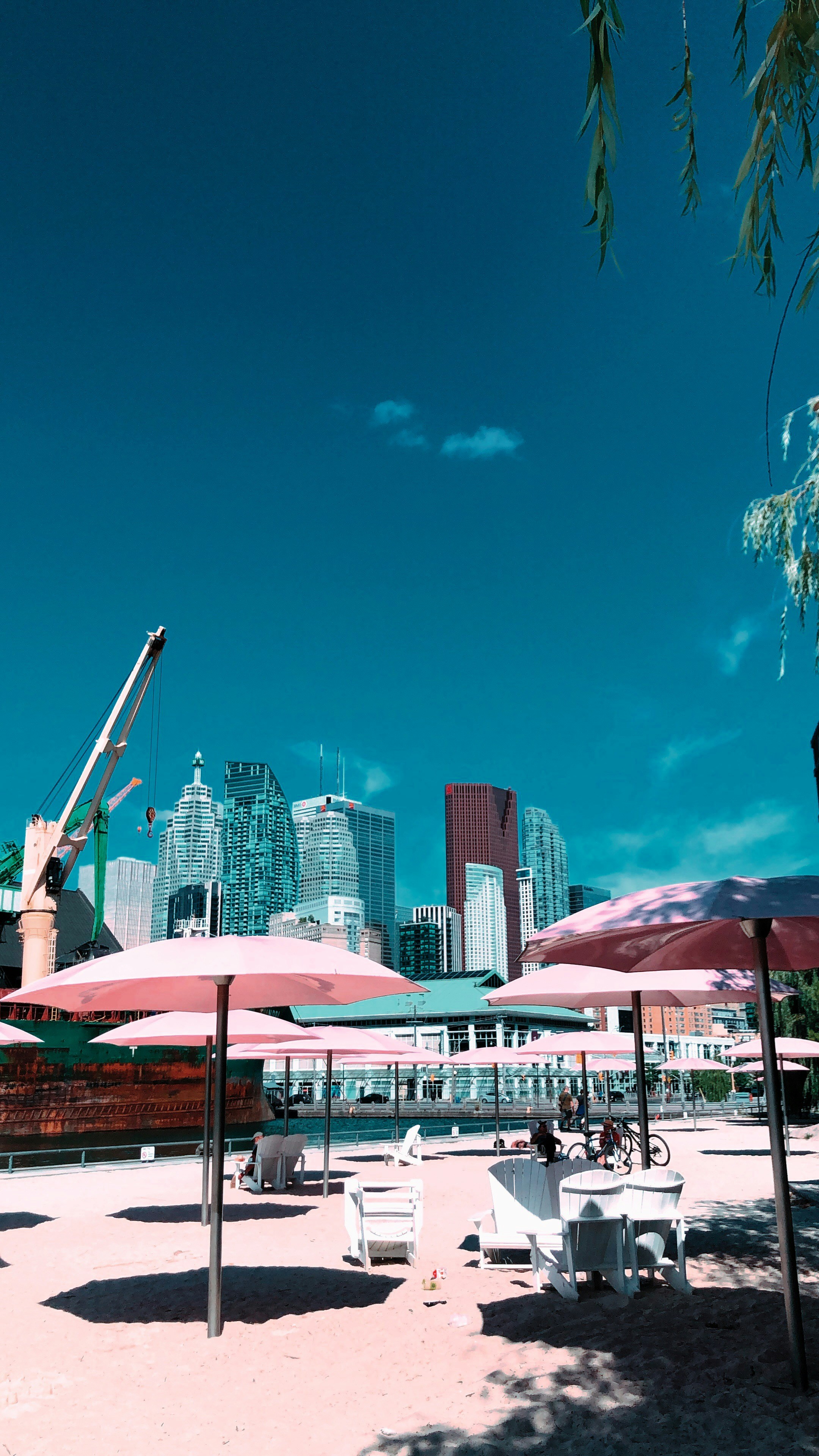 Pastel Parasol Plaza Over a Modern Harbor Skyline