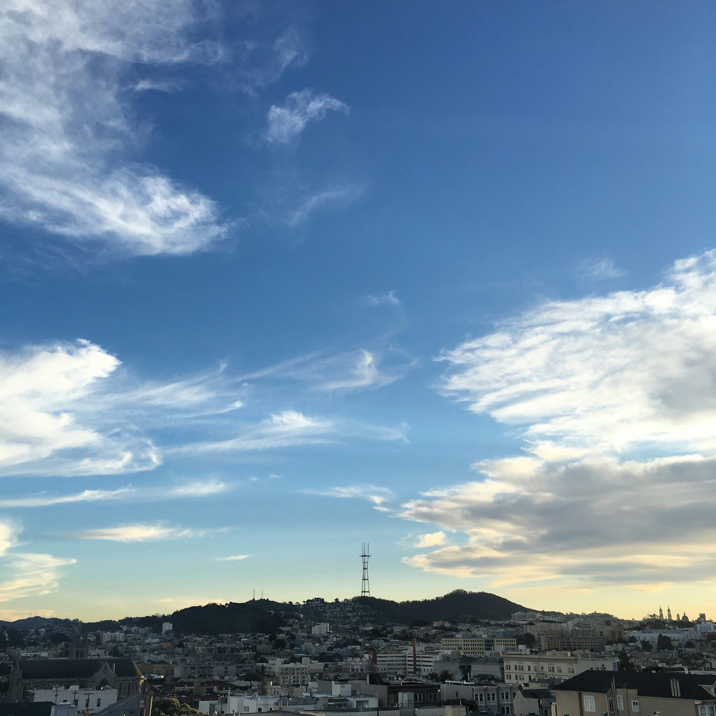 Horizon Sentinel: Tower Crowned Hills Over a Sunlit City