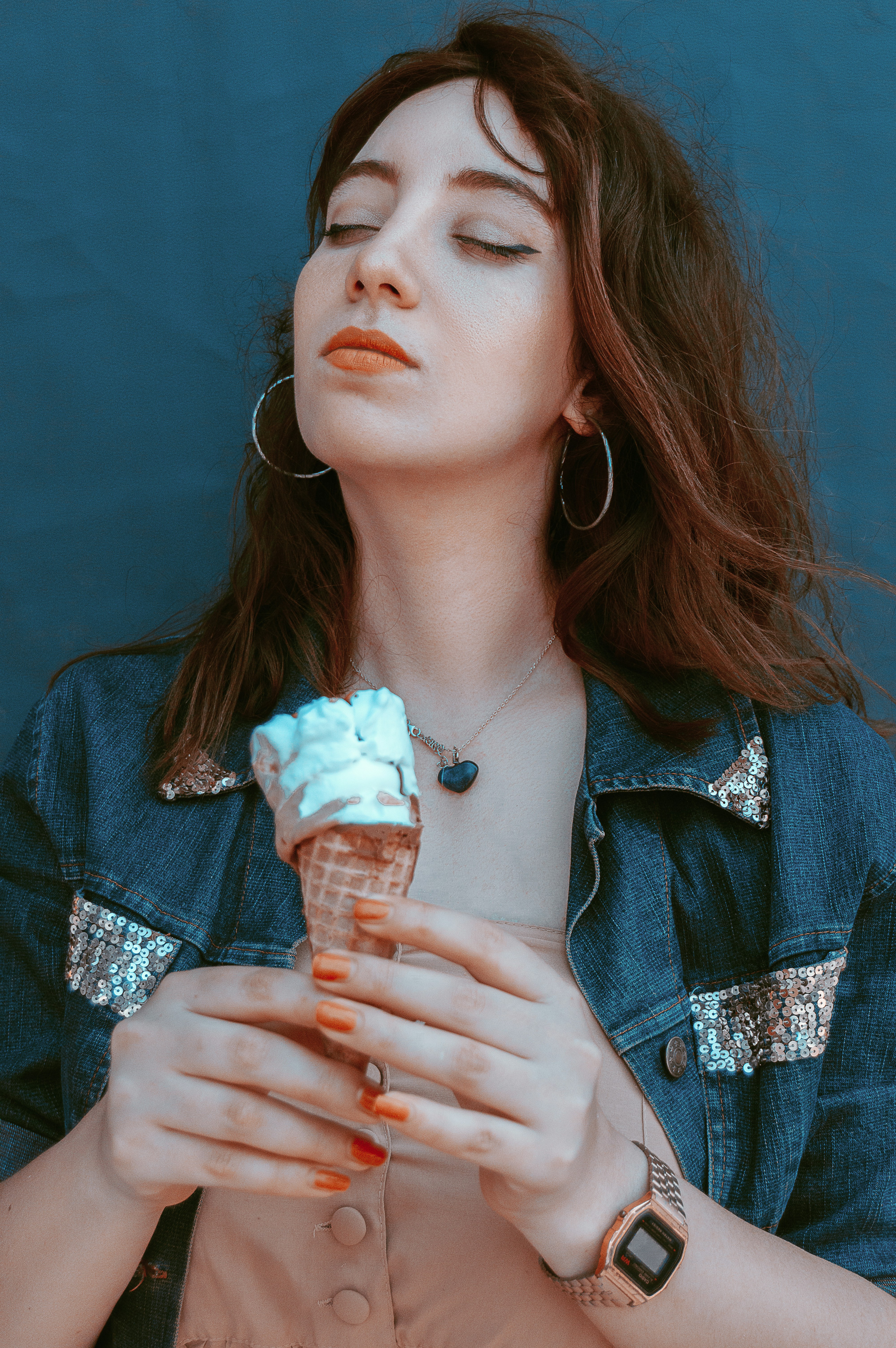 Denim Portrait in a Mint Moment: Quiet Confidence Against a Blue Backdrop