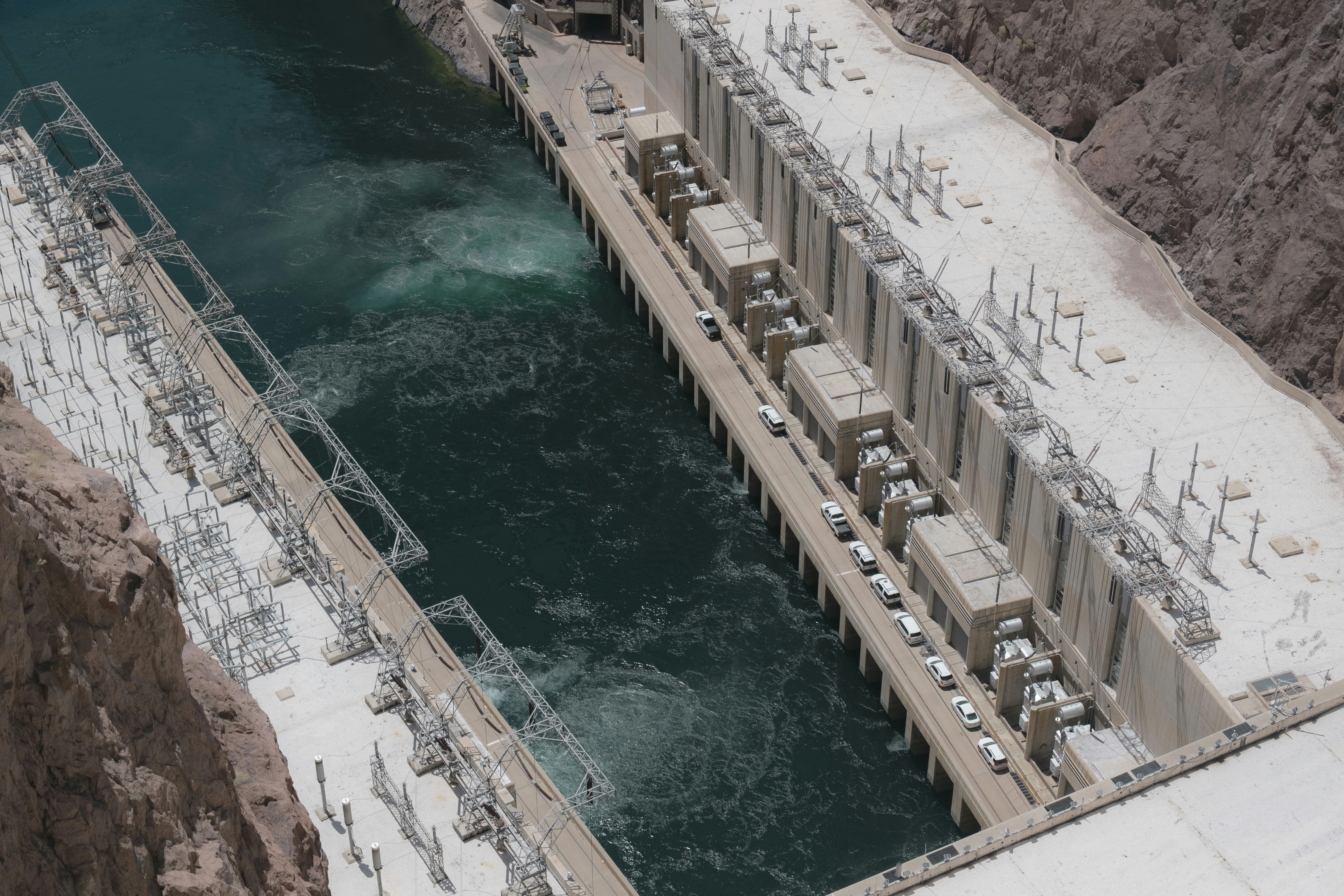 Concrete Spine: Aerial View of a Dam's Central Water Channel and Crest Road