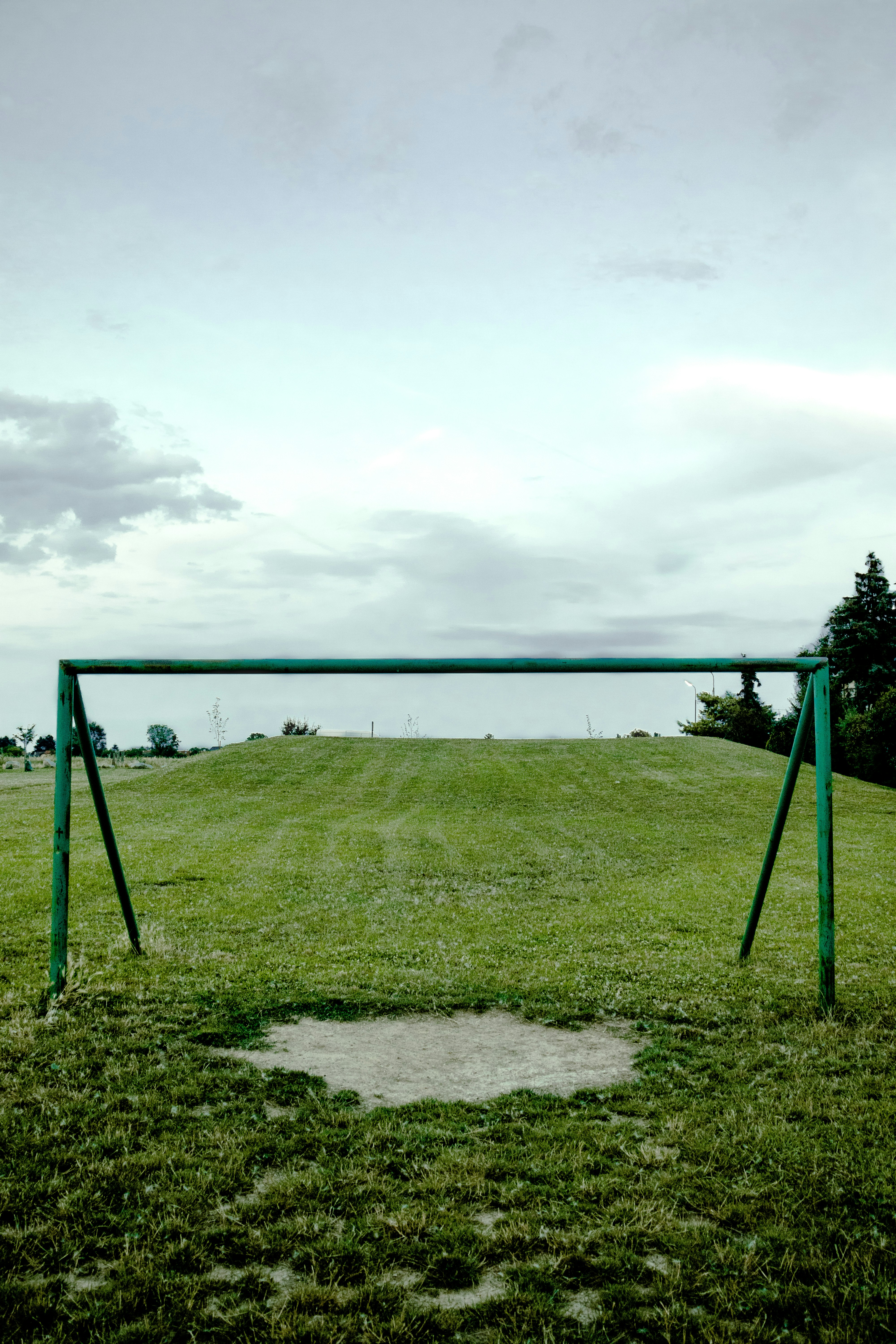 Horizon Gate: A Lone Green Swing Frame in a Quiet Park