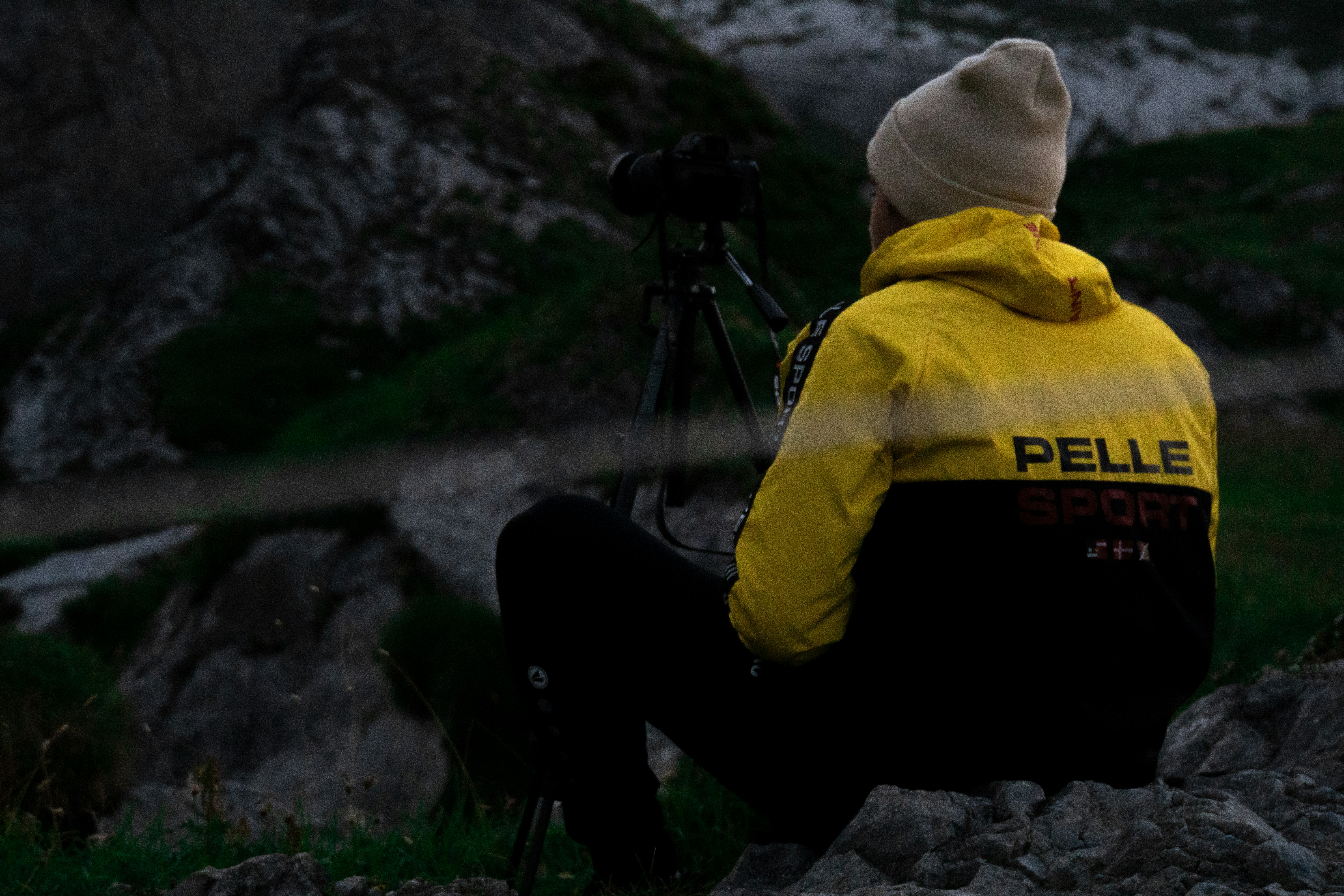 Remote Photographer in a Yellow Jacket Loops a Sunset Story