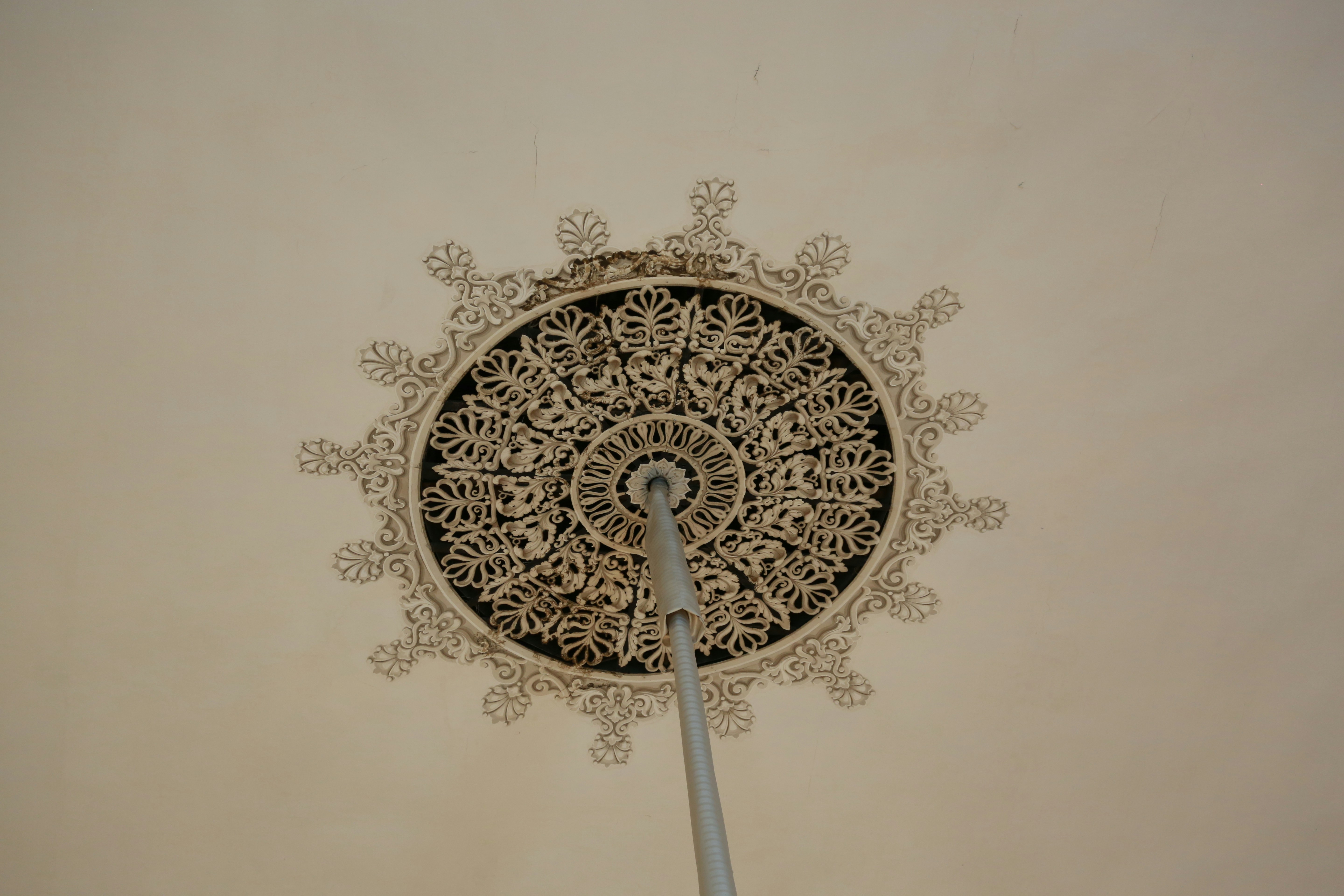 Centerpiece of Filigree: The Ceiling Medallion Anchored by a Slender Rod
