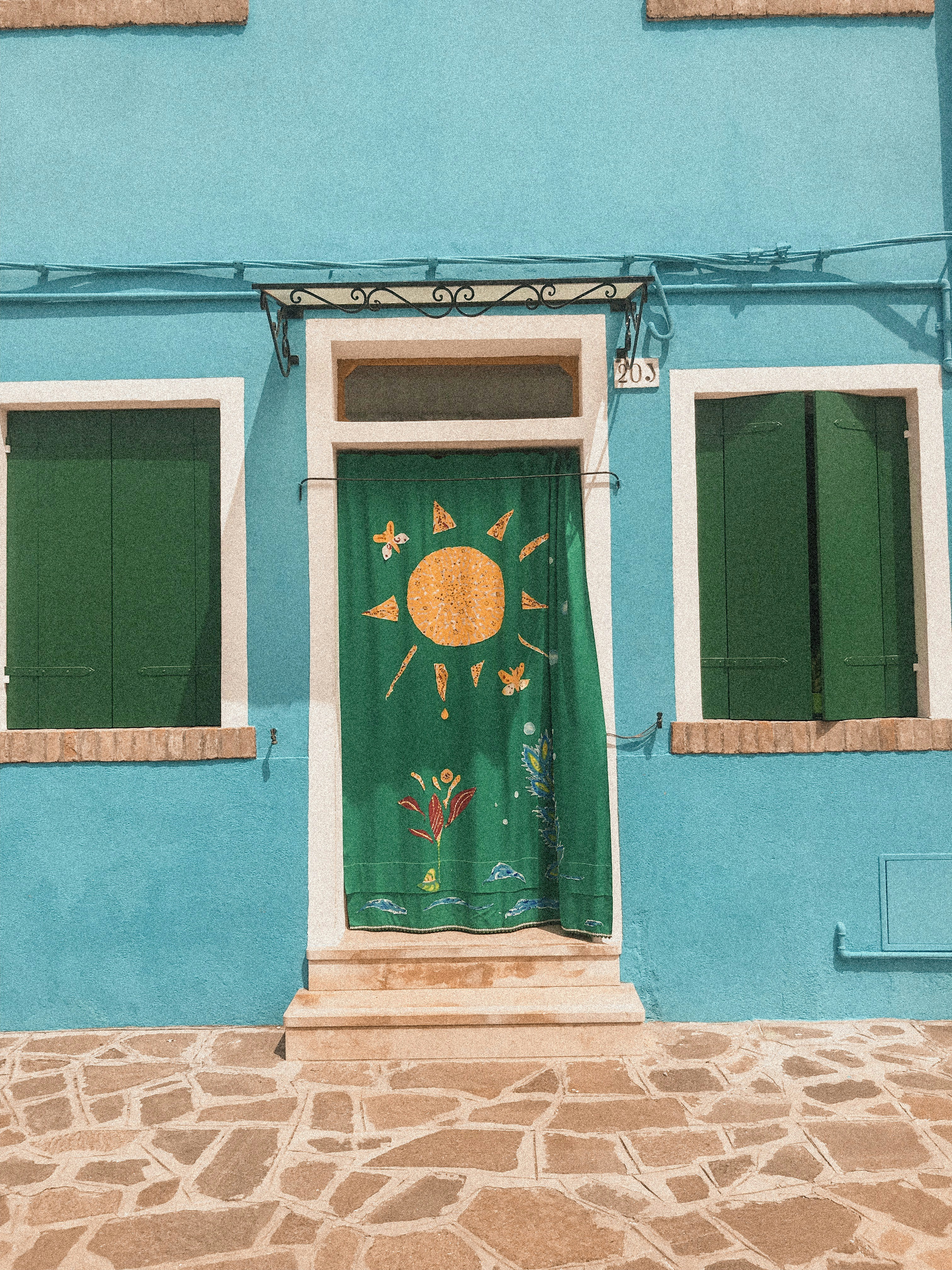 Sunburst Doorway on a Turquoise Mediterranean Facade